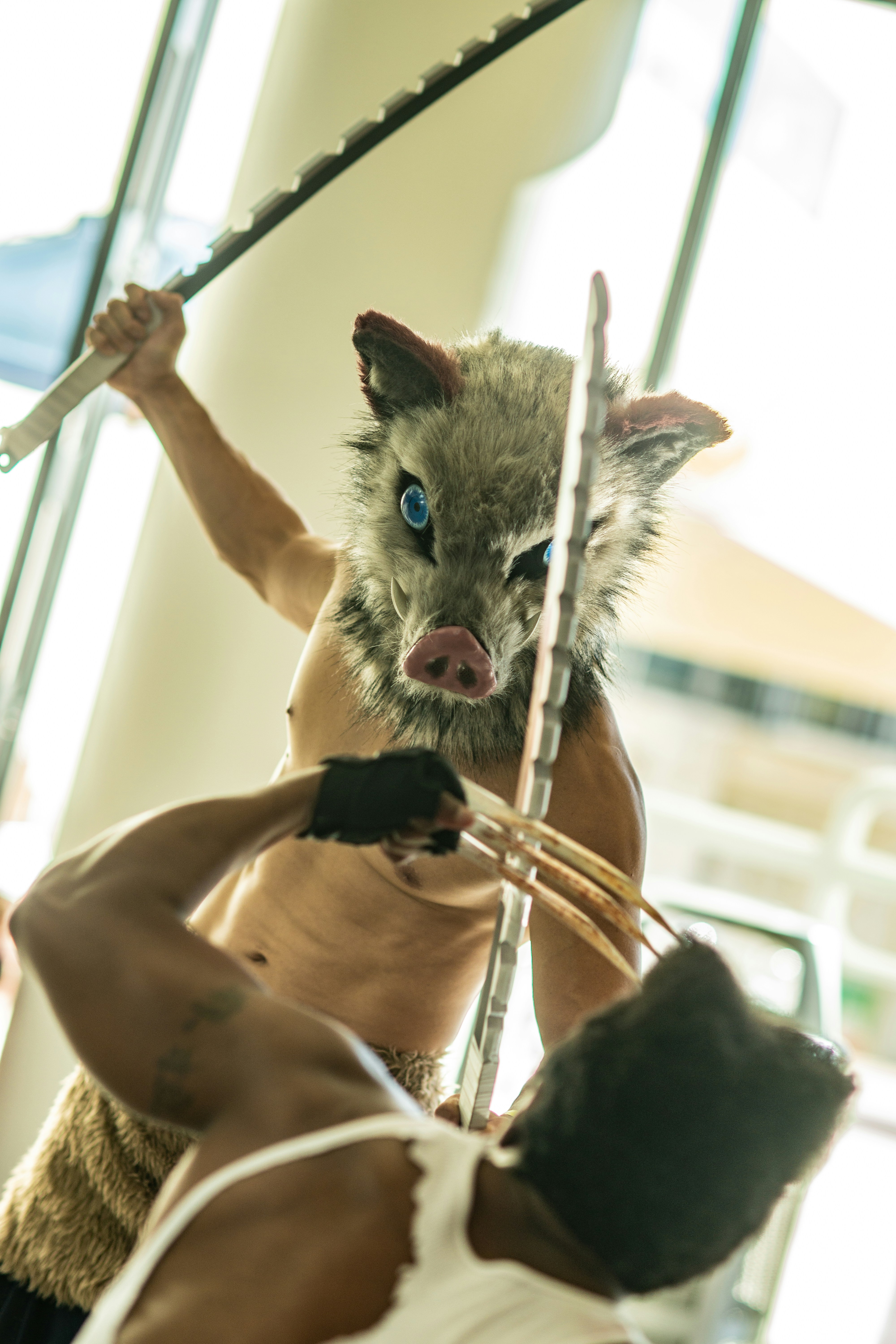 A fierce duel between two combatants, one wearing a wild boar mask, wielding a weapon in a dynamic pose. The intensity of the moment captures the essence of a mythical battle.