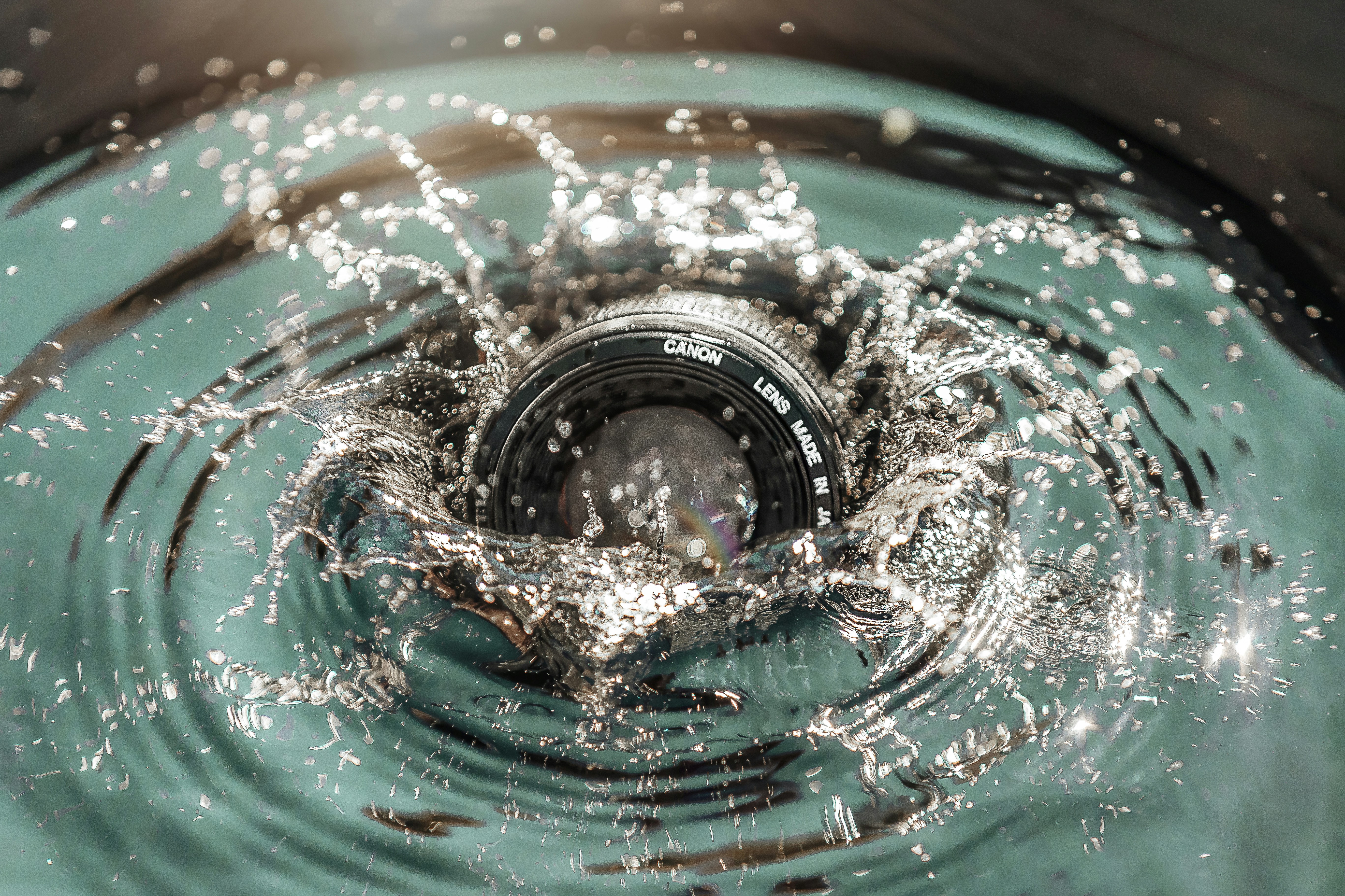 Turquoise Whirlpool Encircling a Canon Lens