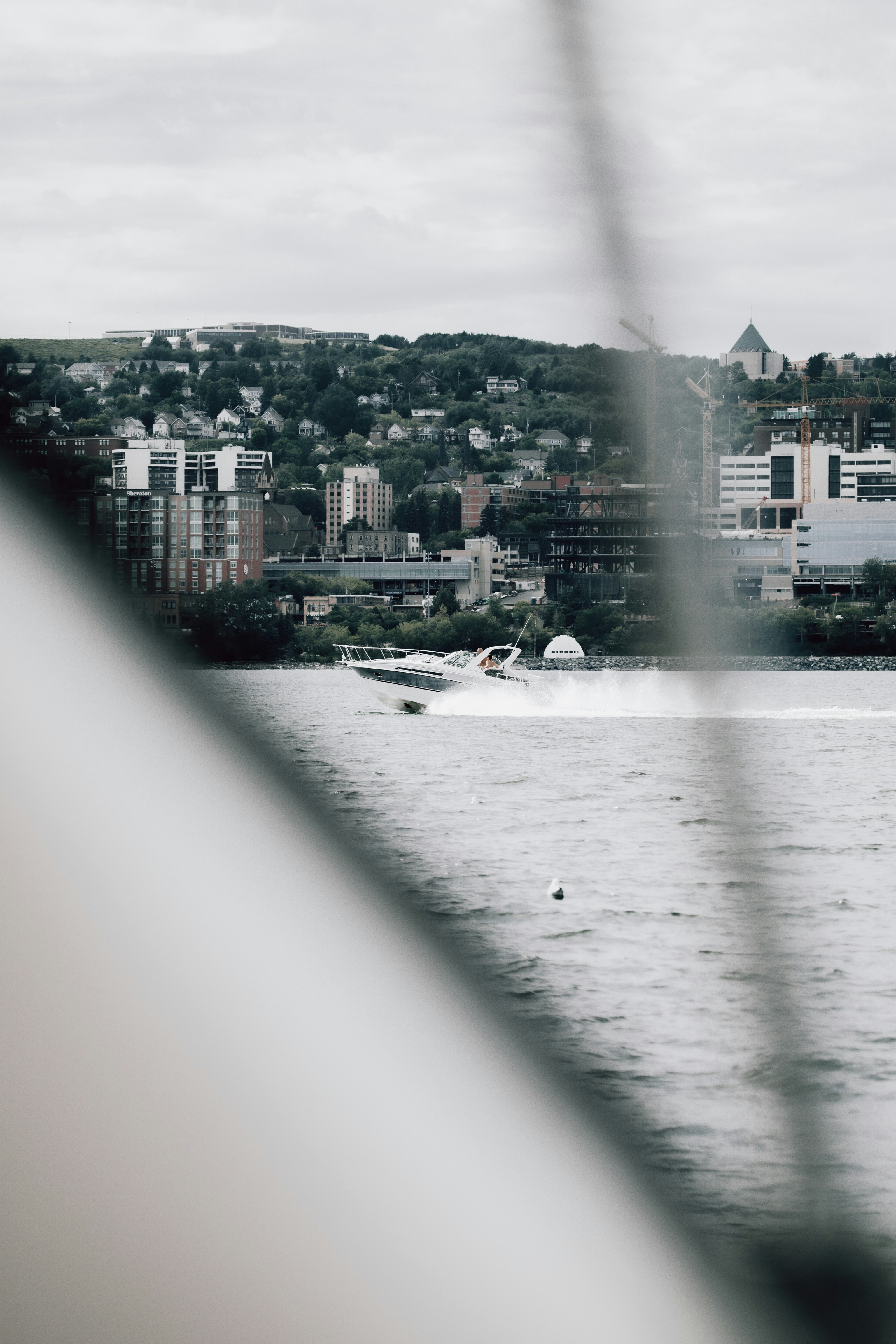 Harbor Sprint: a speedboat carving through a misty city skyline