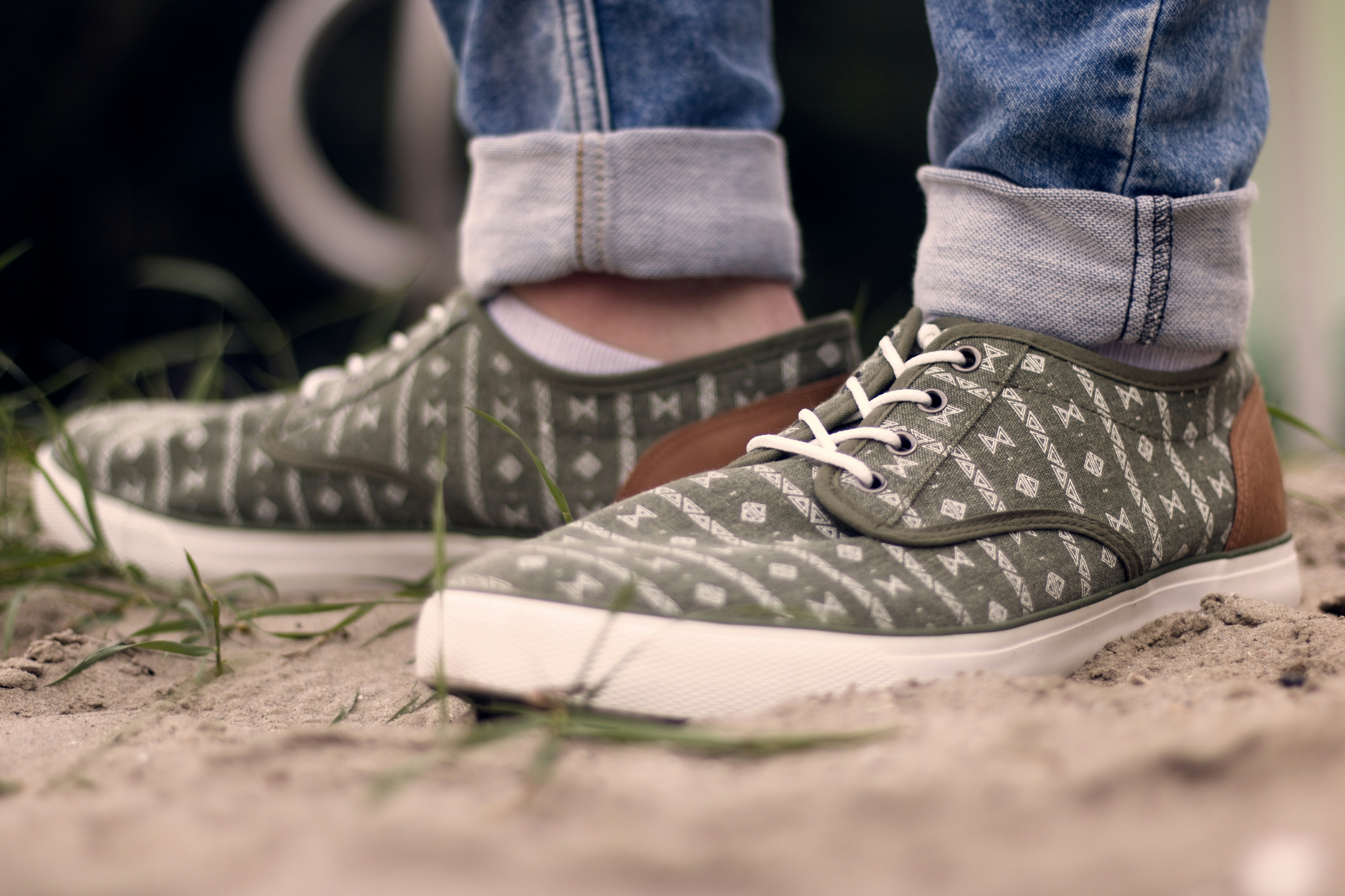 Grounded in pattern: patterned sneakers anchor a sunlit sandy frame