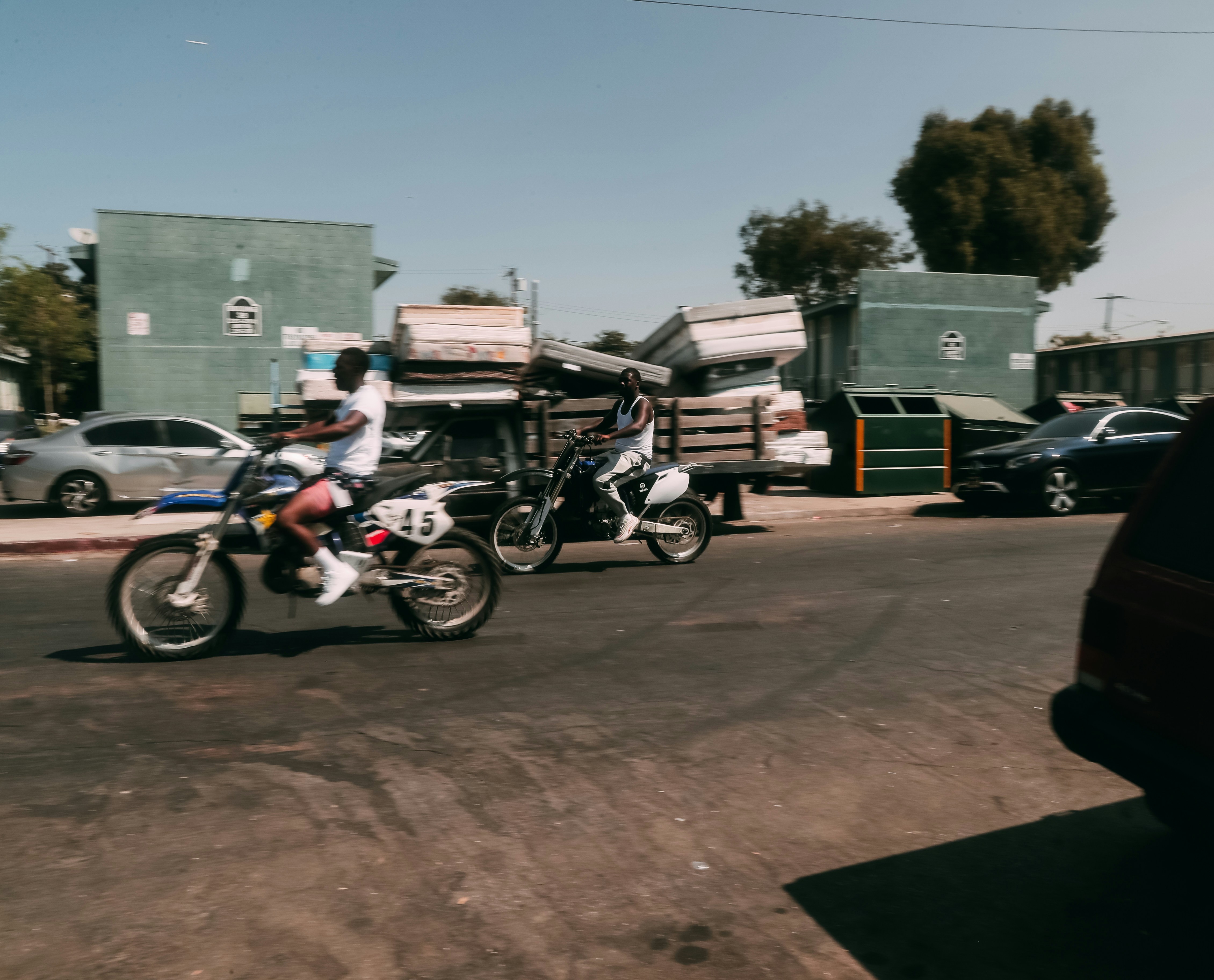 Morning Sprint: Blurred Motion of Motorcycles by a Pallet Yard