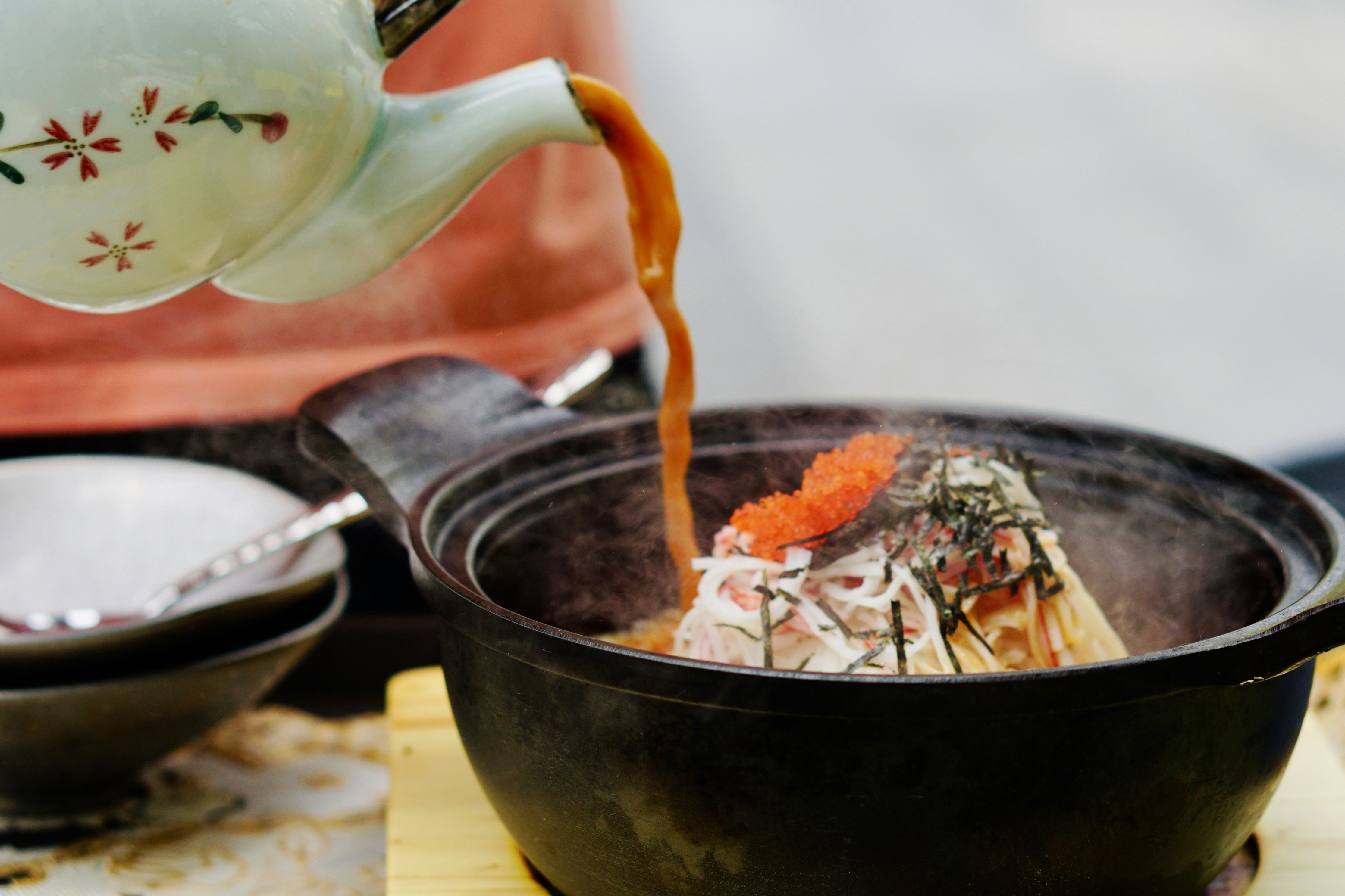 Steam-Kissed Donburi: Roe-Topped Comfort Beneath a Pouring Teapot