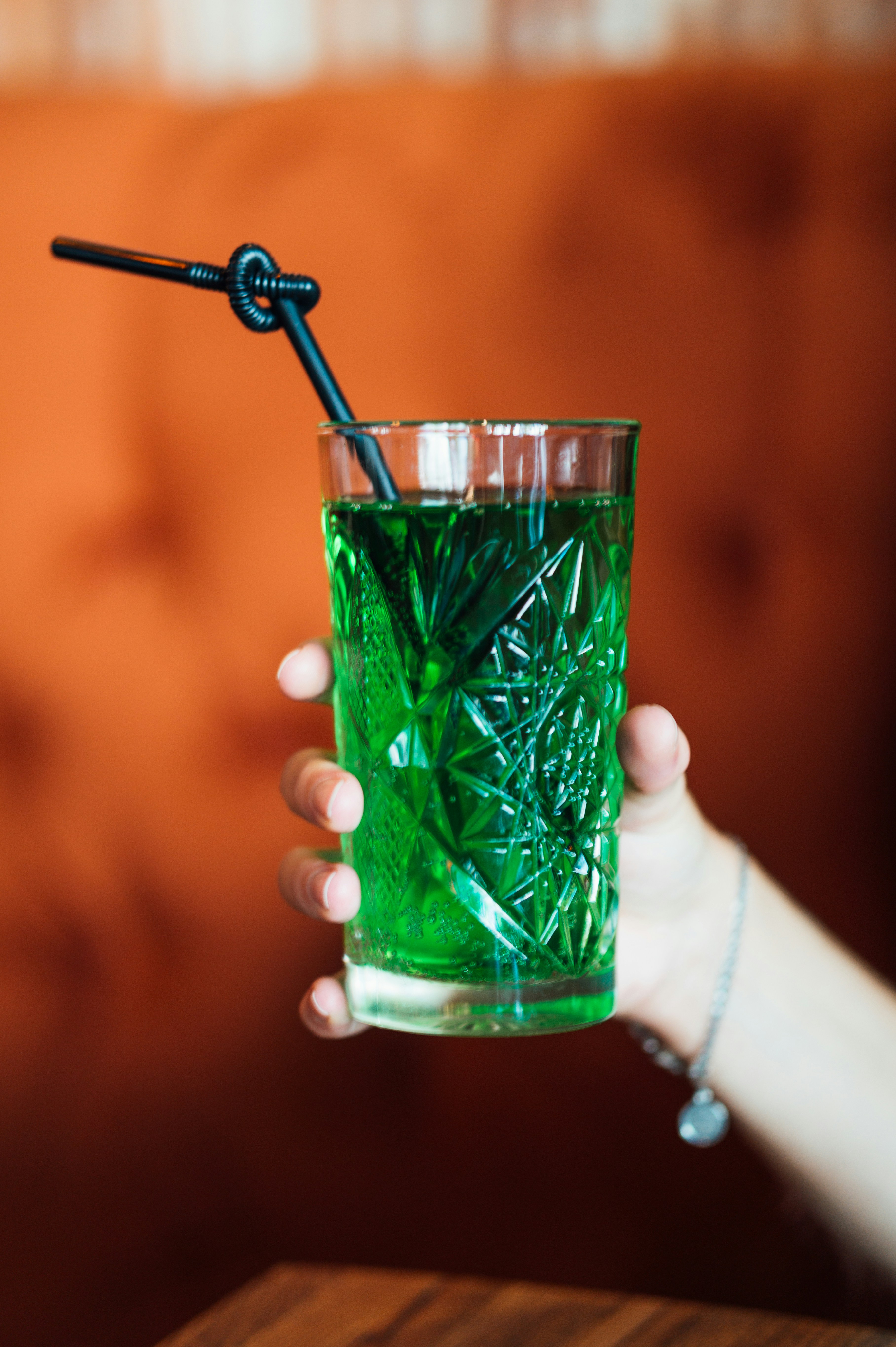 Emerald Glass in Hand: Craft-Cut Reflections