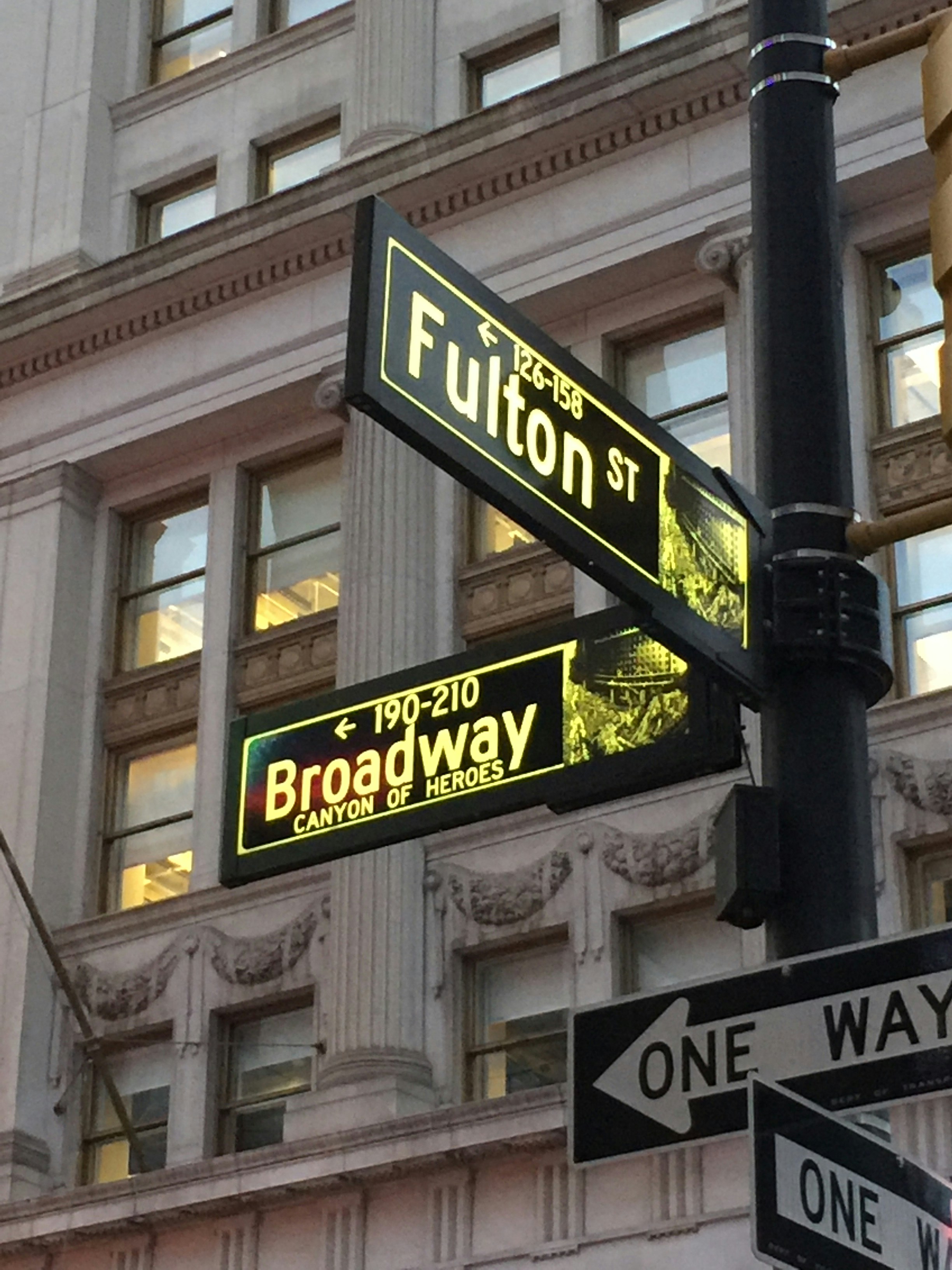 Urban Street Signs at a Classical Facade