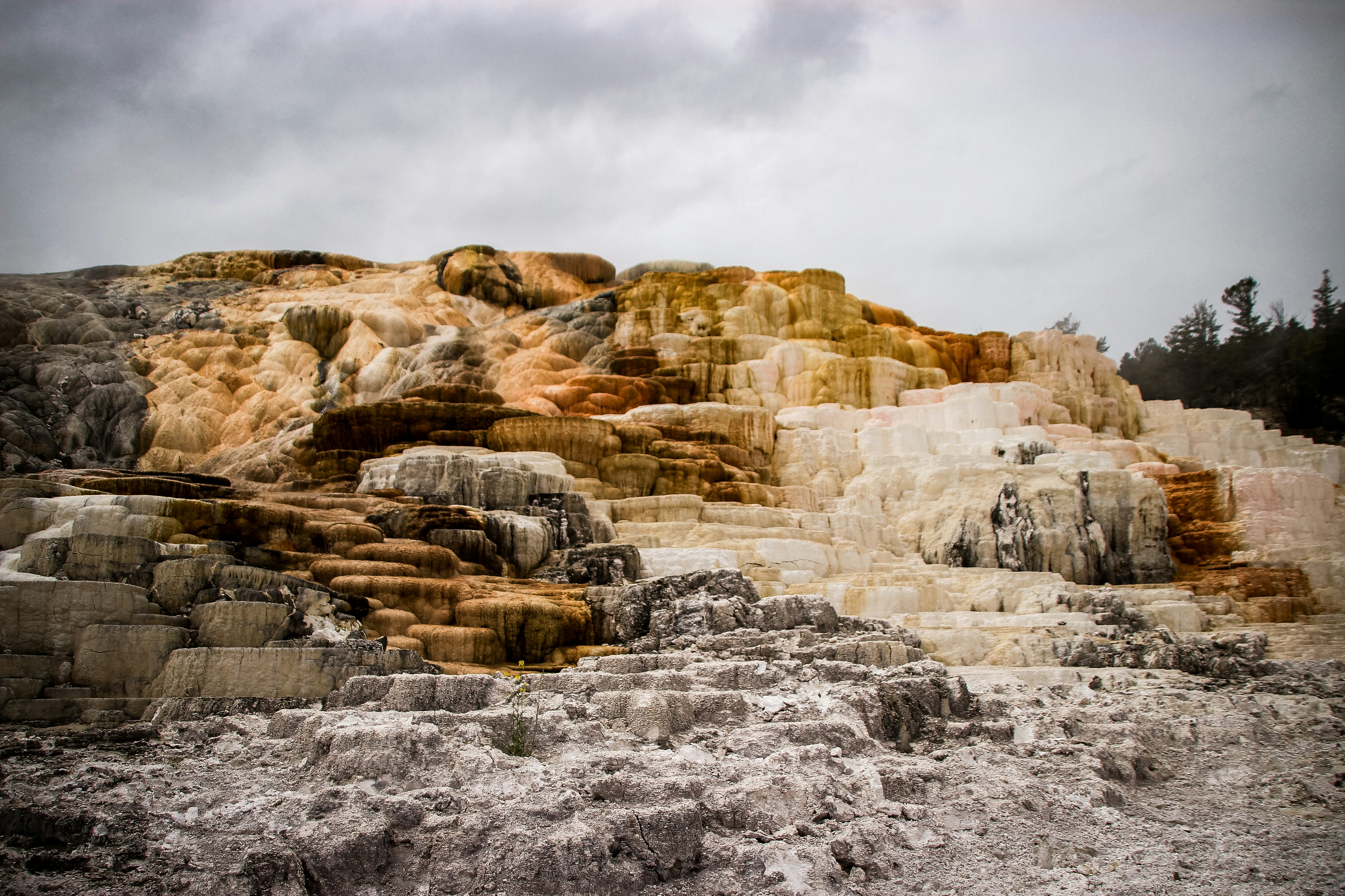 Ember-Terraced Outcrop Under a Distant Cloud