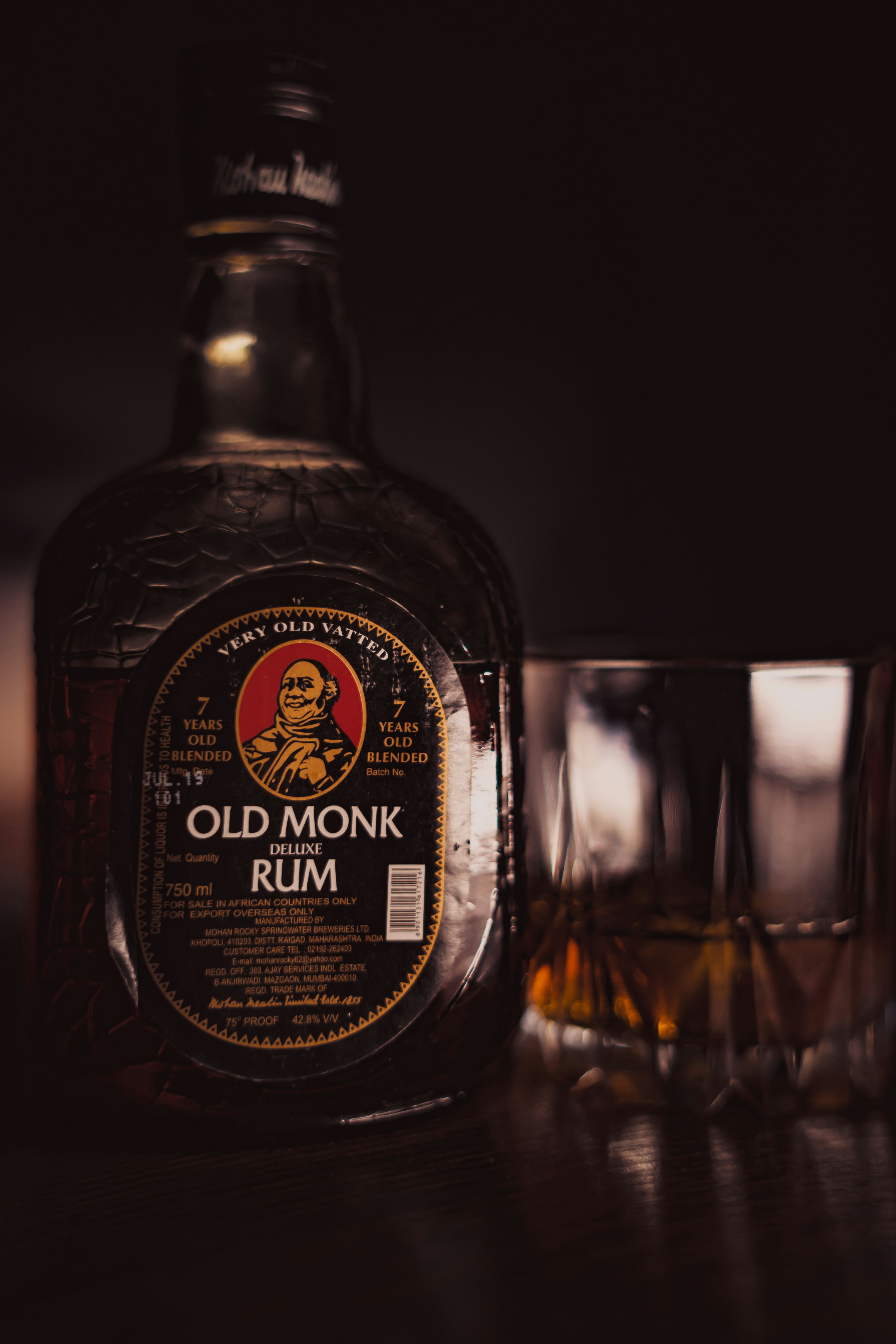 Midnight Amber: Old Monk Bottle Lighting the Quiet Bar