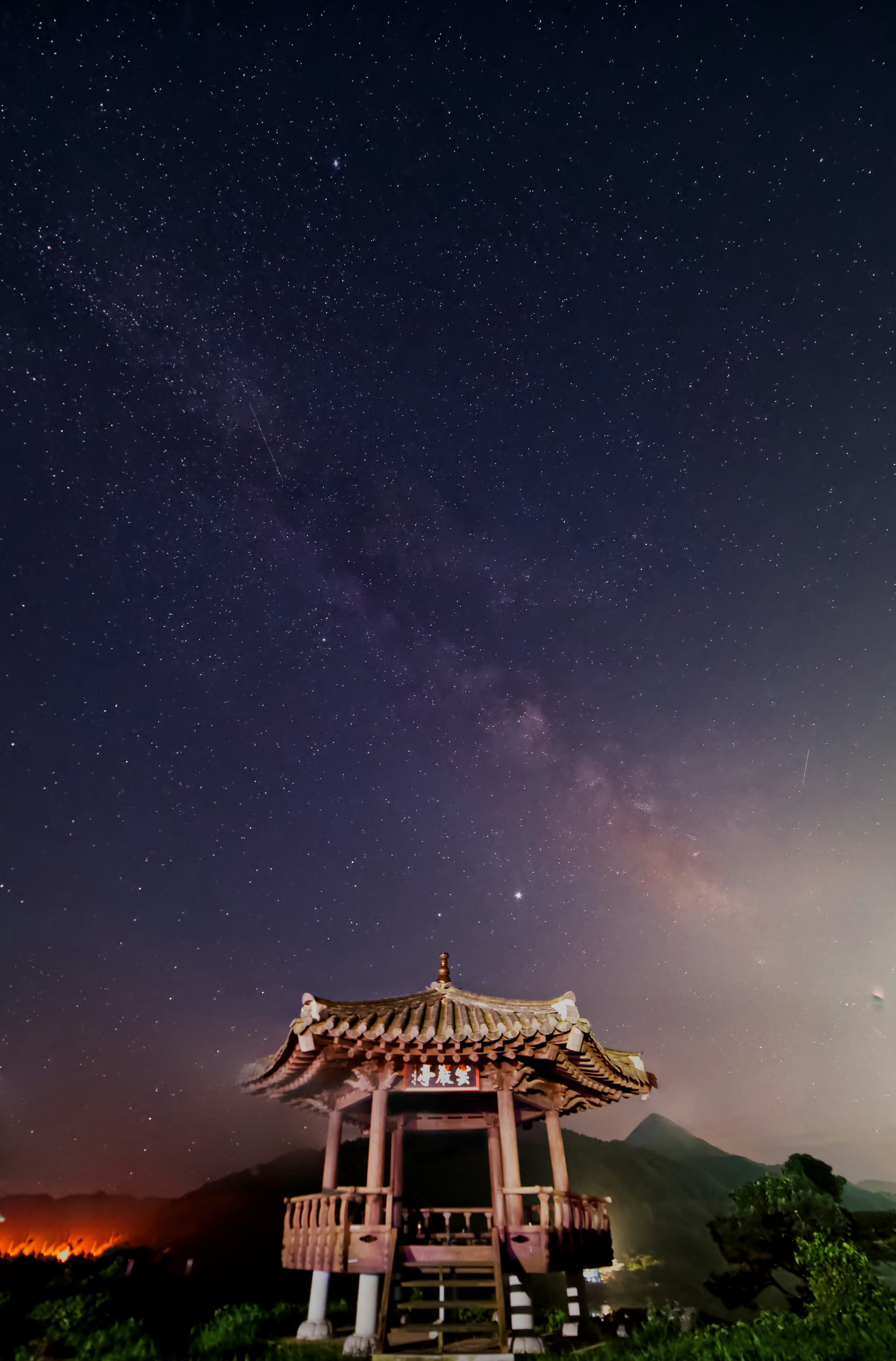 Milky Way Over a Lanterned Pavilion: Night Sky Above the Hillside Temple