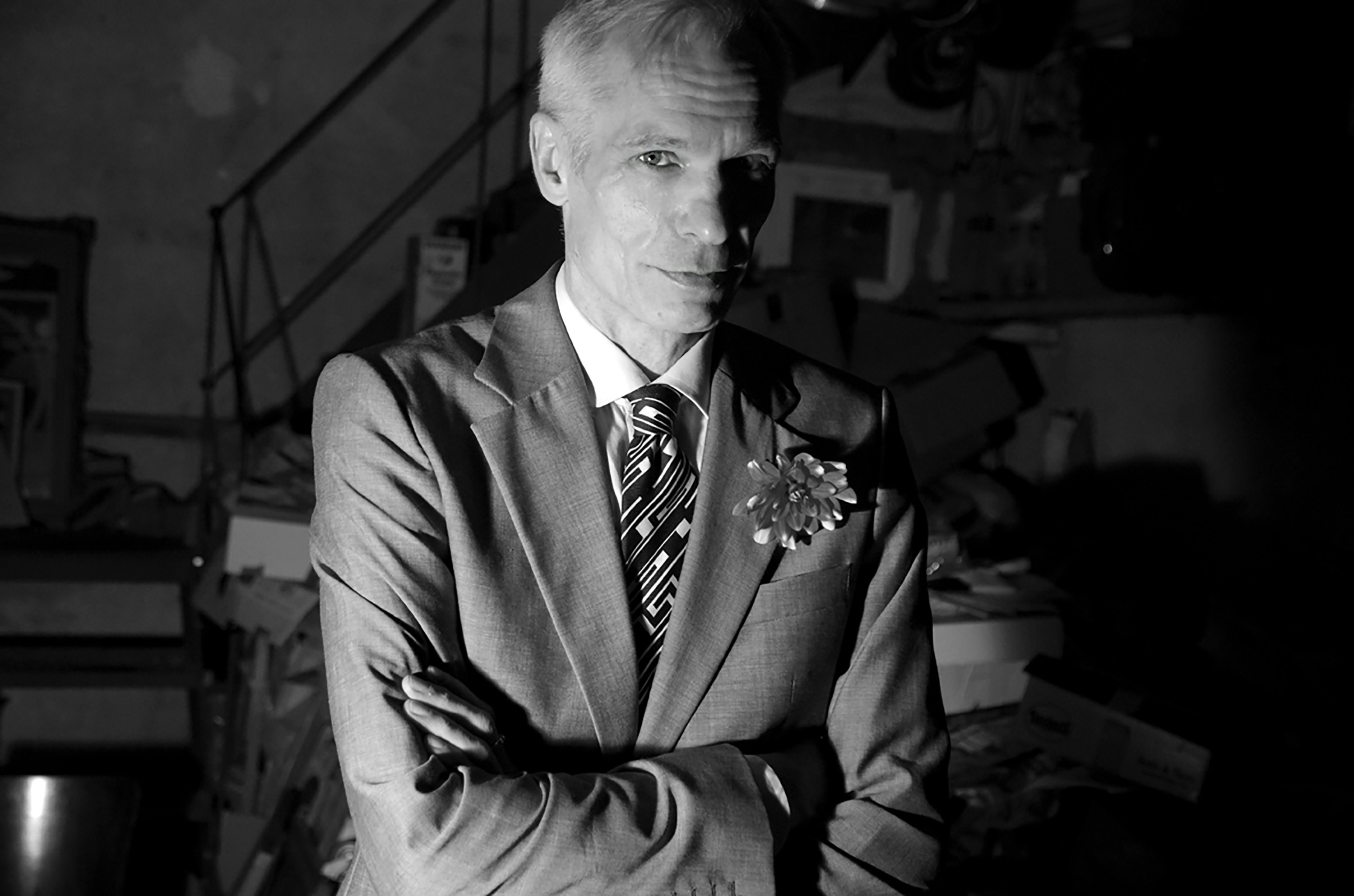 Shadowed Dignity: A Mono Portrait in a Cluttered Studio