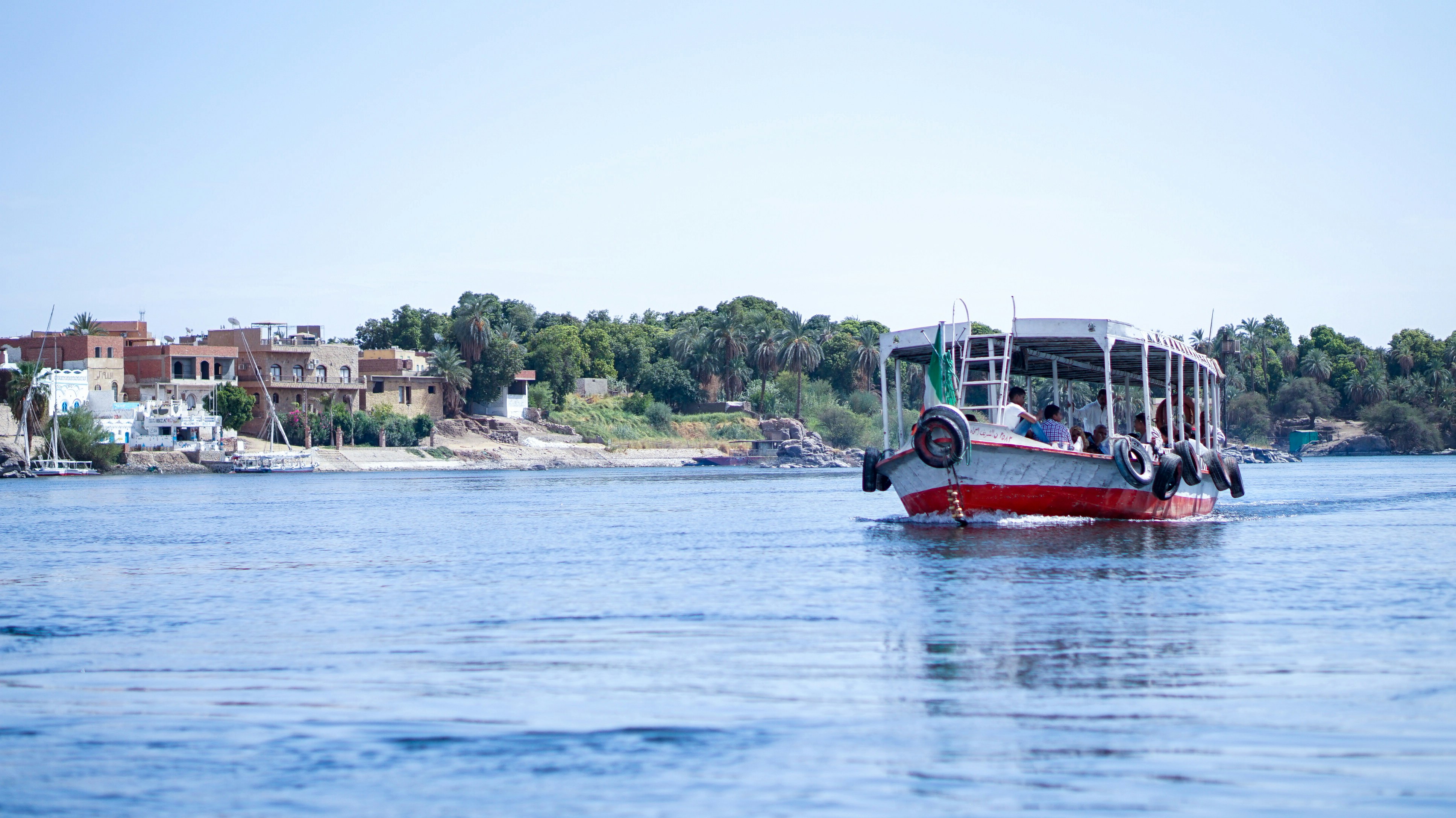 red and white boat on body of water during daytime