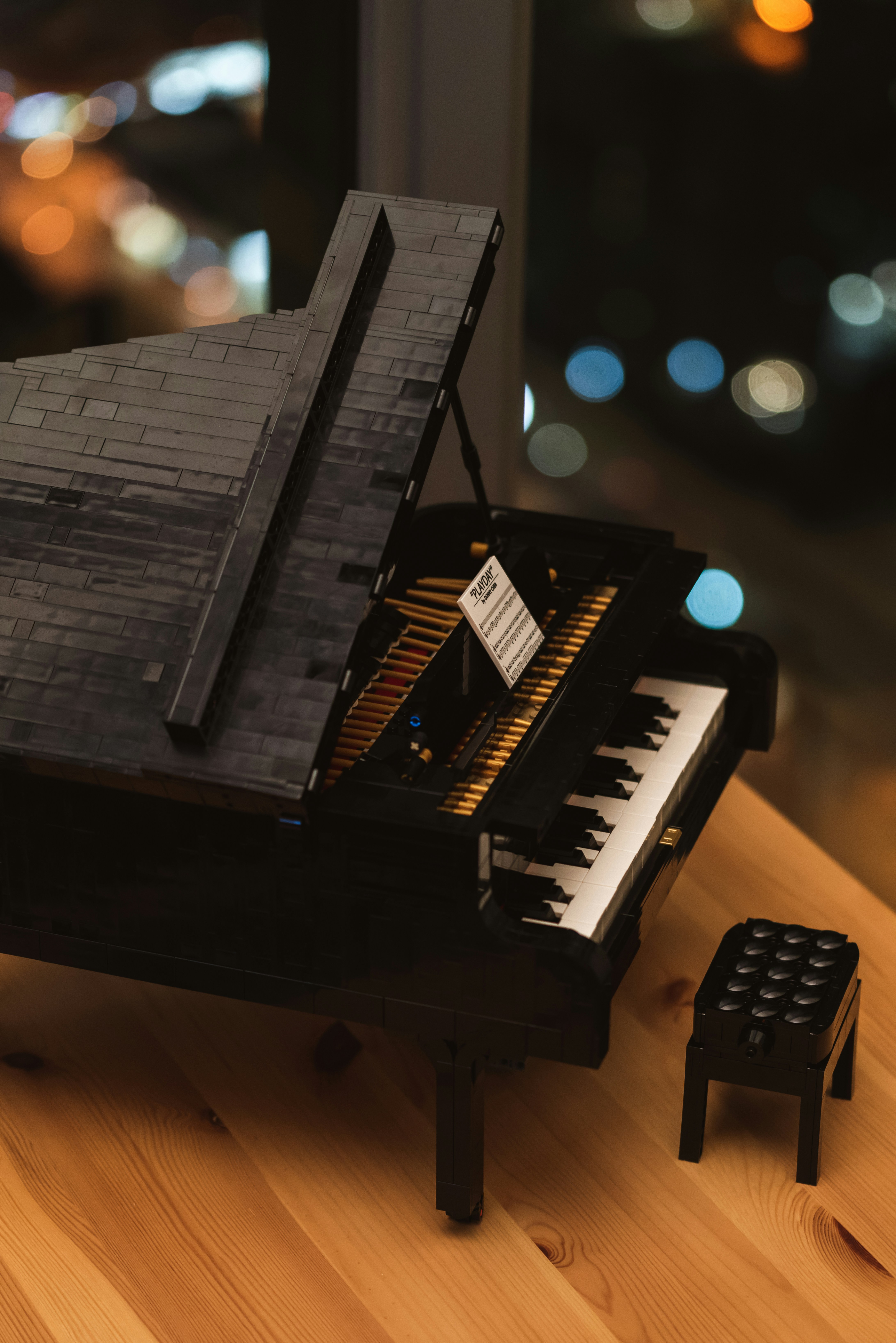 Midnight Mini: A Foldable Upright Piano Surfaces on a Wooden Stage