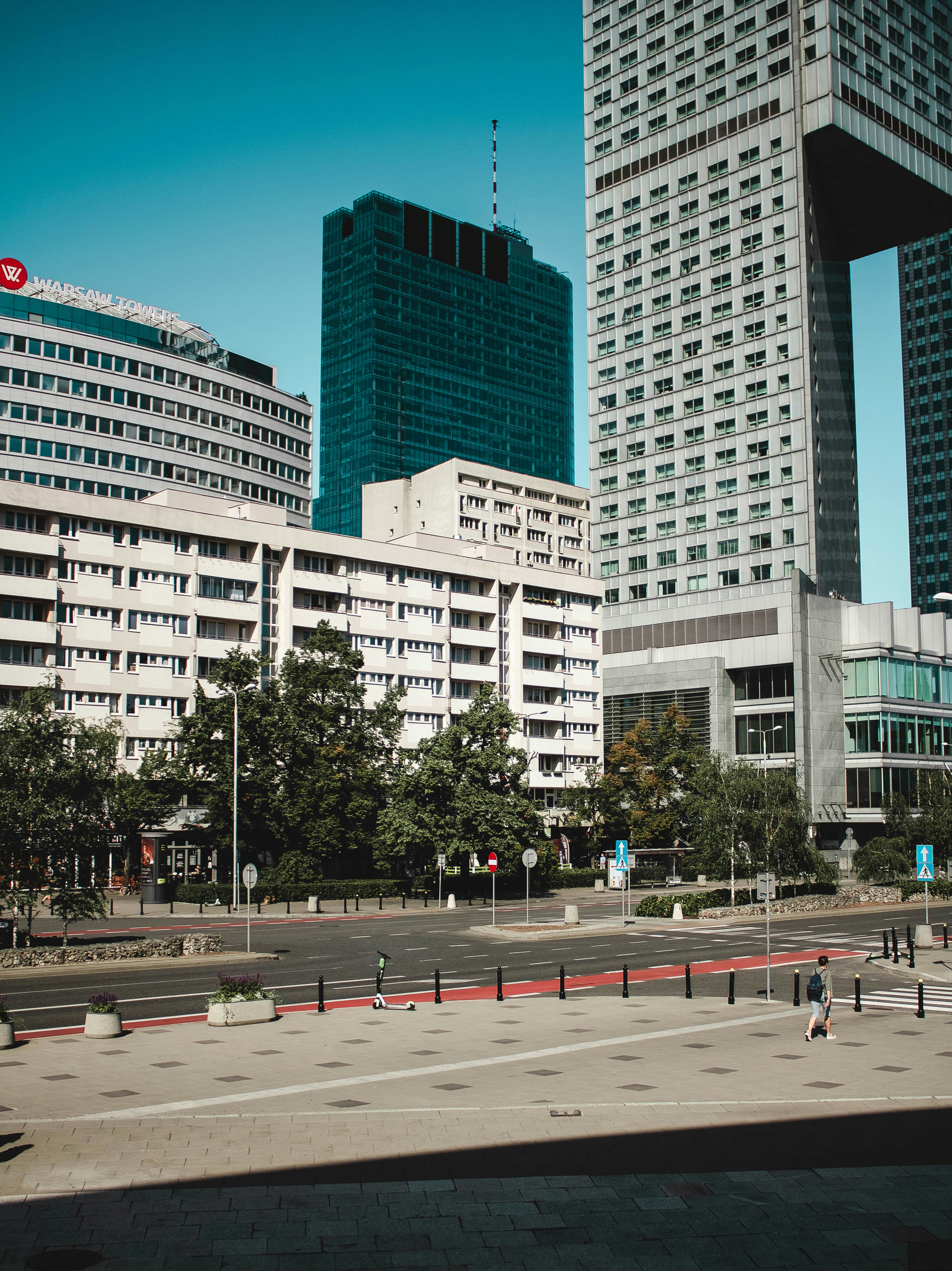 People walking on sidewalk near high rise buildings during daytime ...