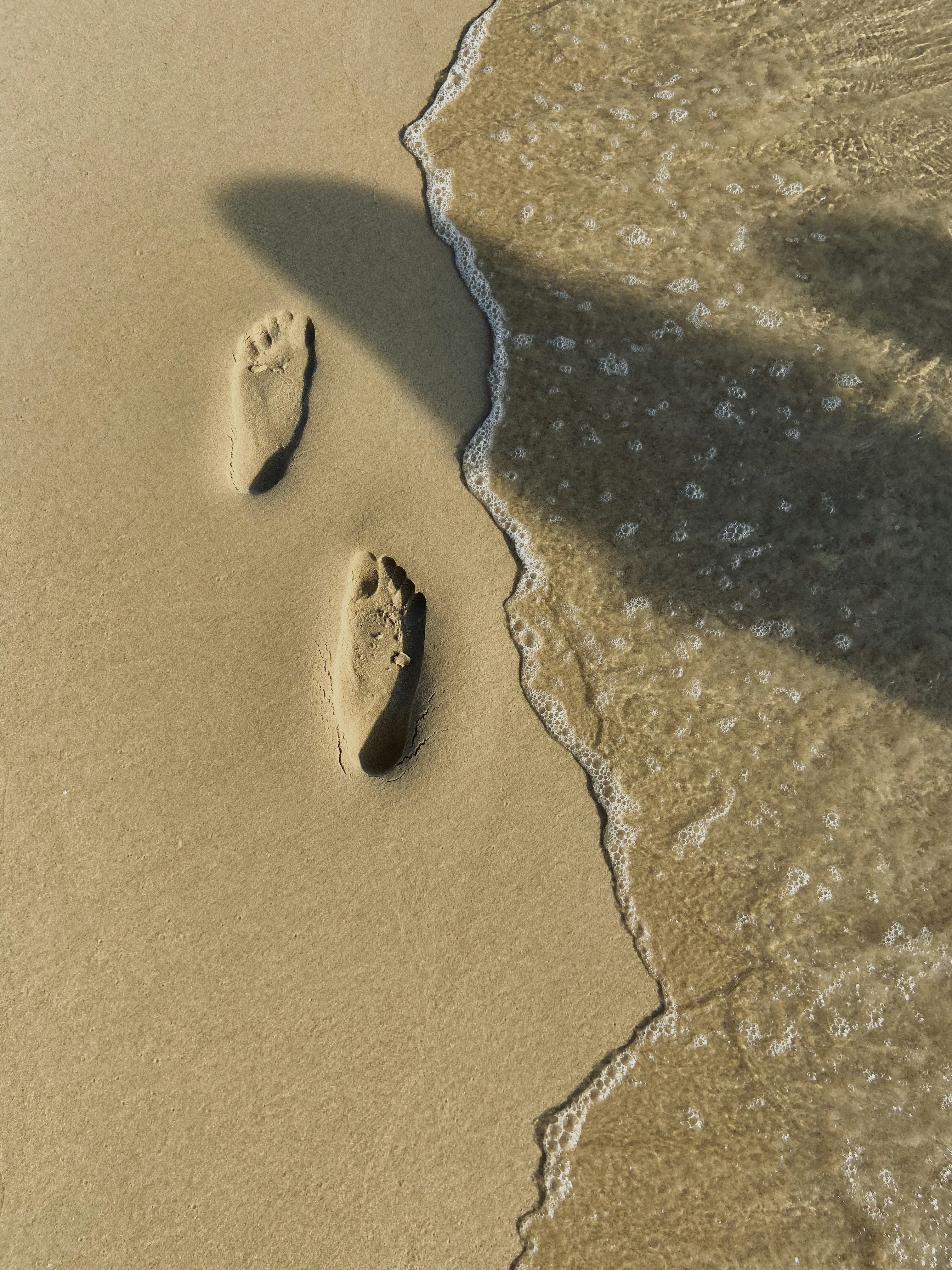 Twin Footprints at the Tide's Quiet Edge