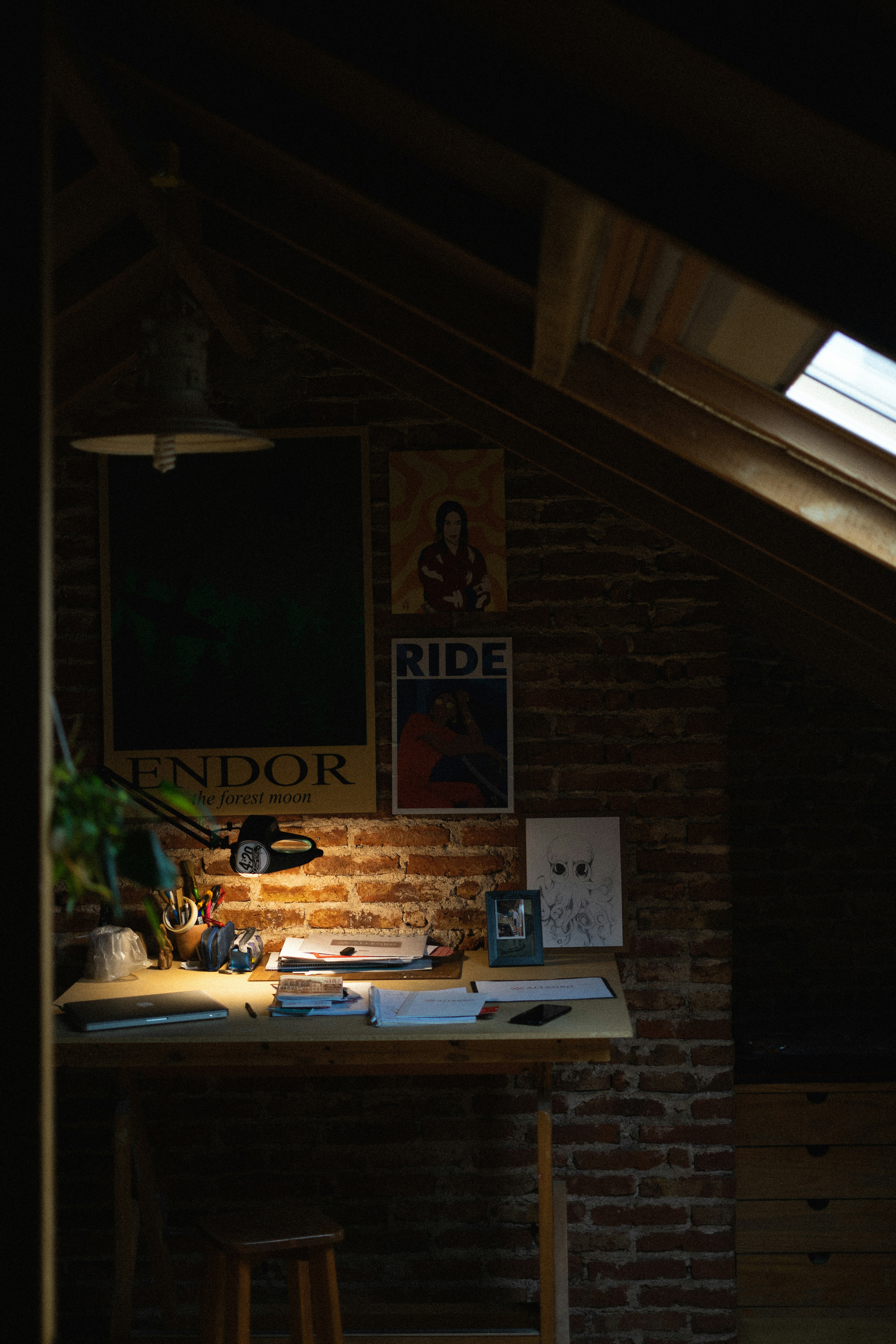 Attic Desk Glow: Brick-Walled Studio Under a Slanted Skylight