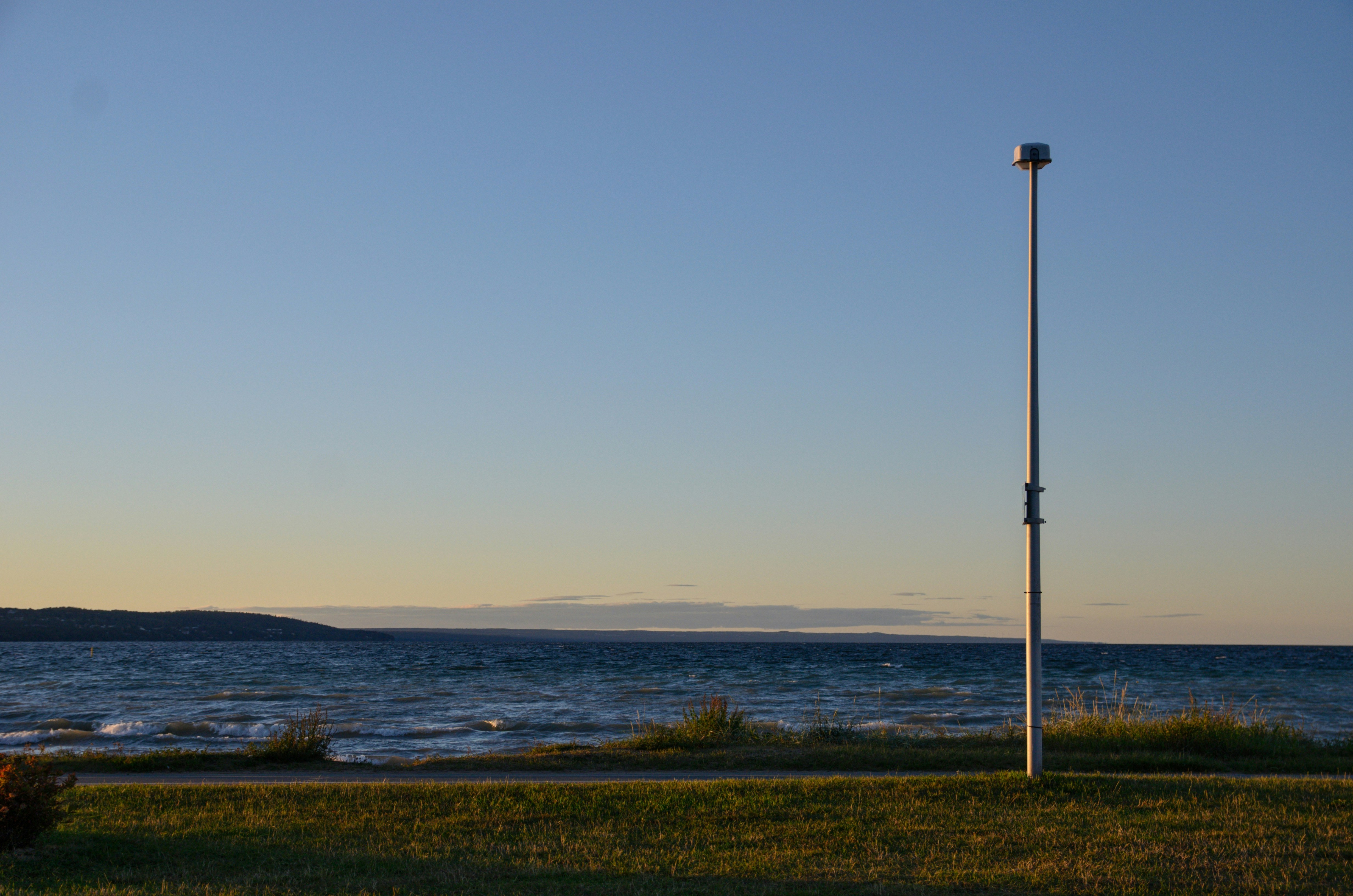 Lone Lamppost at Dusk Over a Tranquil Lake