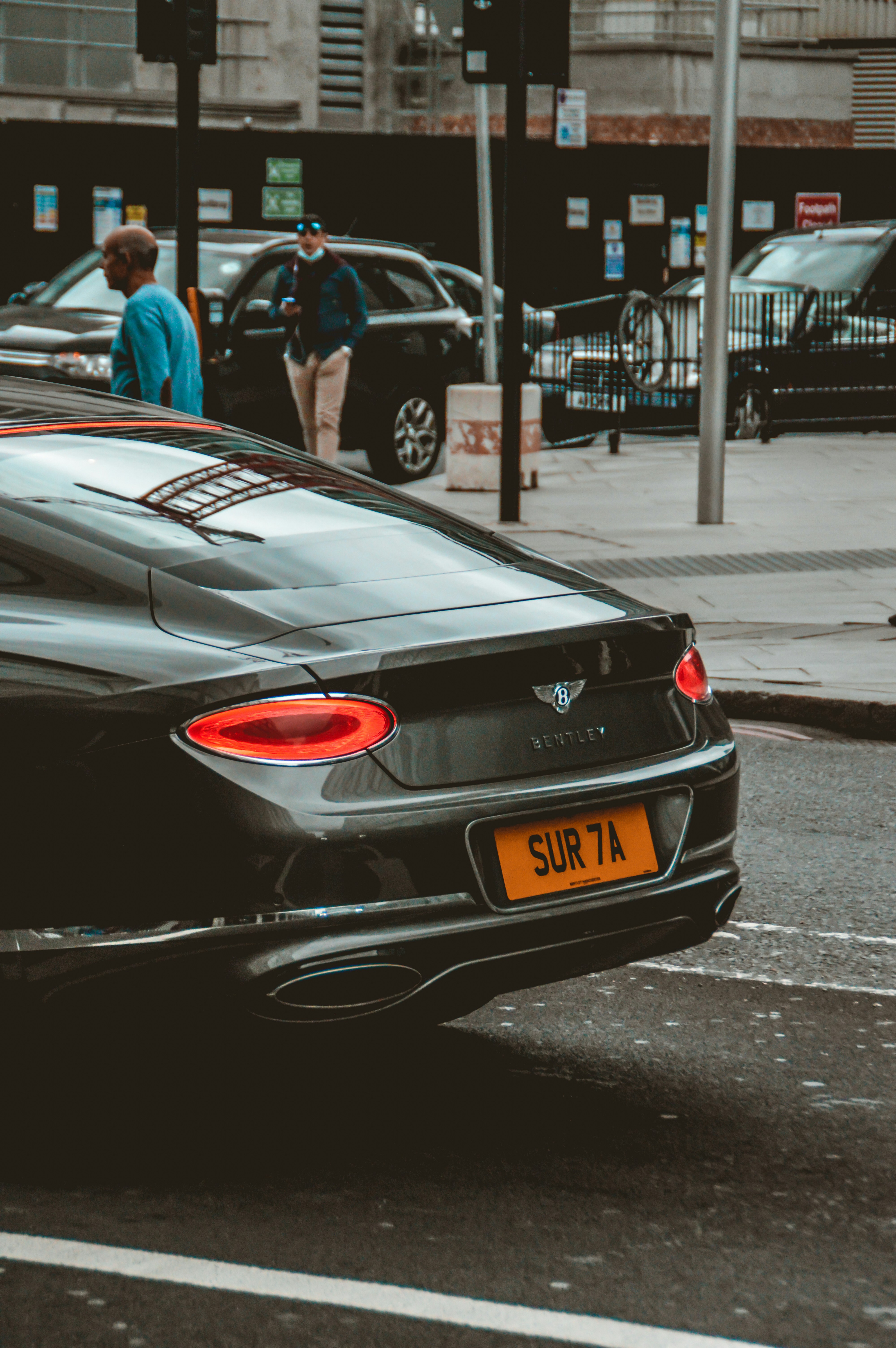 Amber Plate, Black Bentley: Street-Level Portrait at Dusk