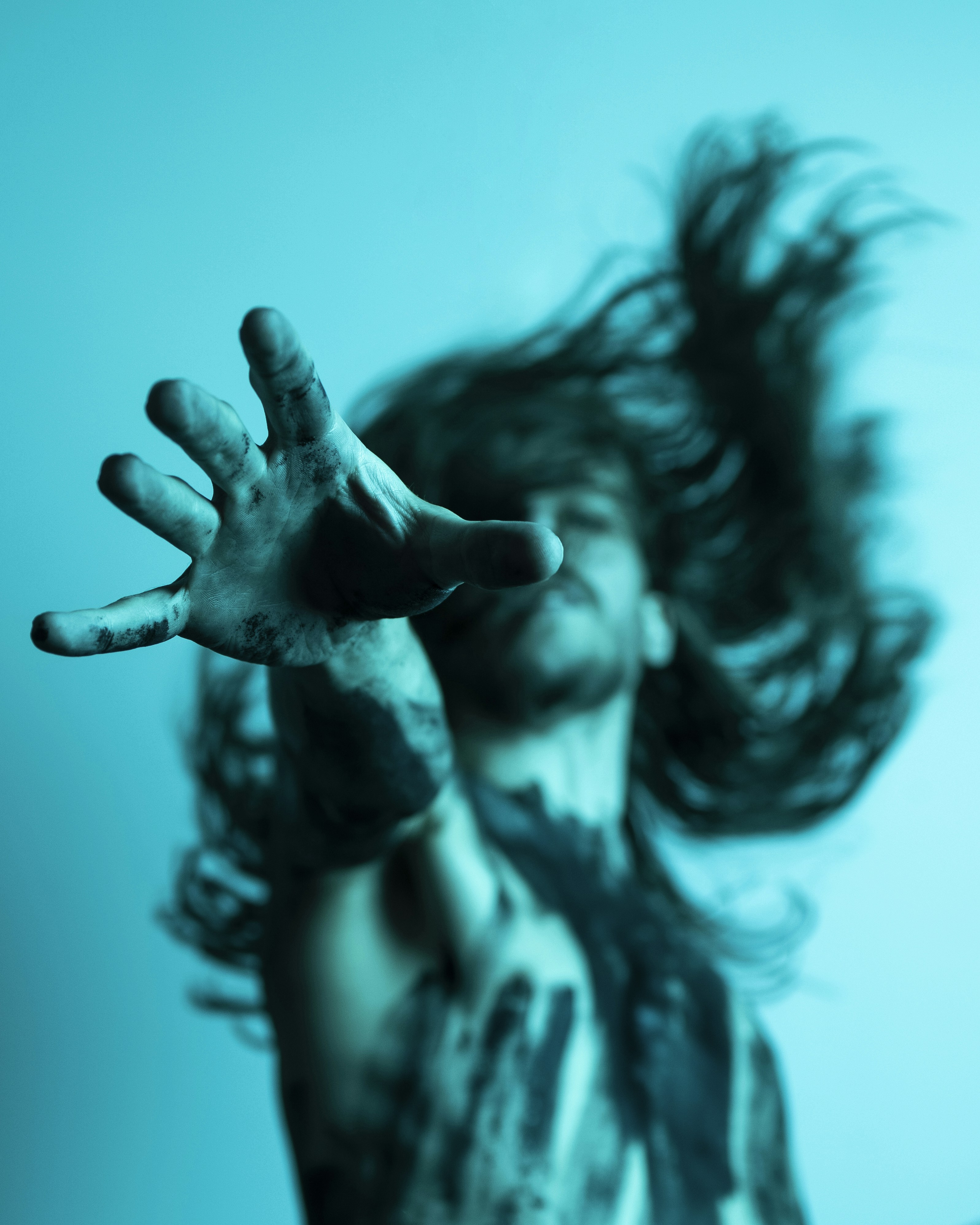 Reach Toward the Blue Light: A Frenzied Figure in Motion