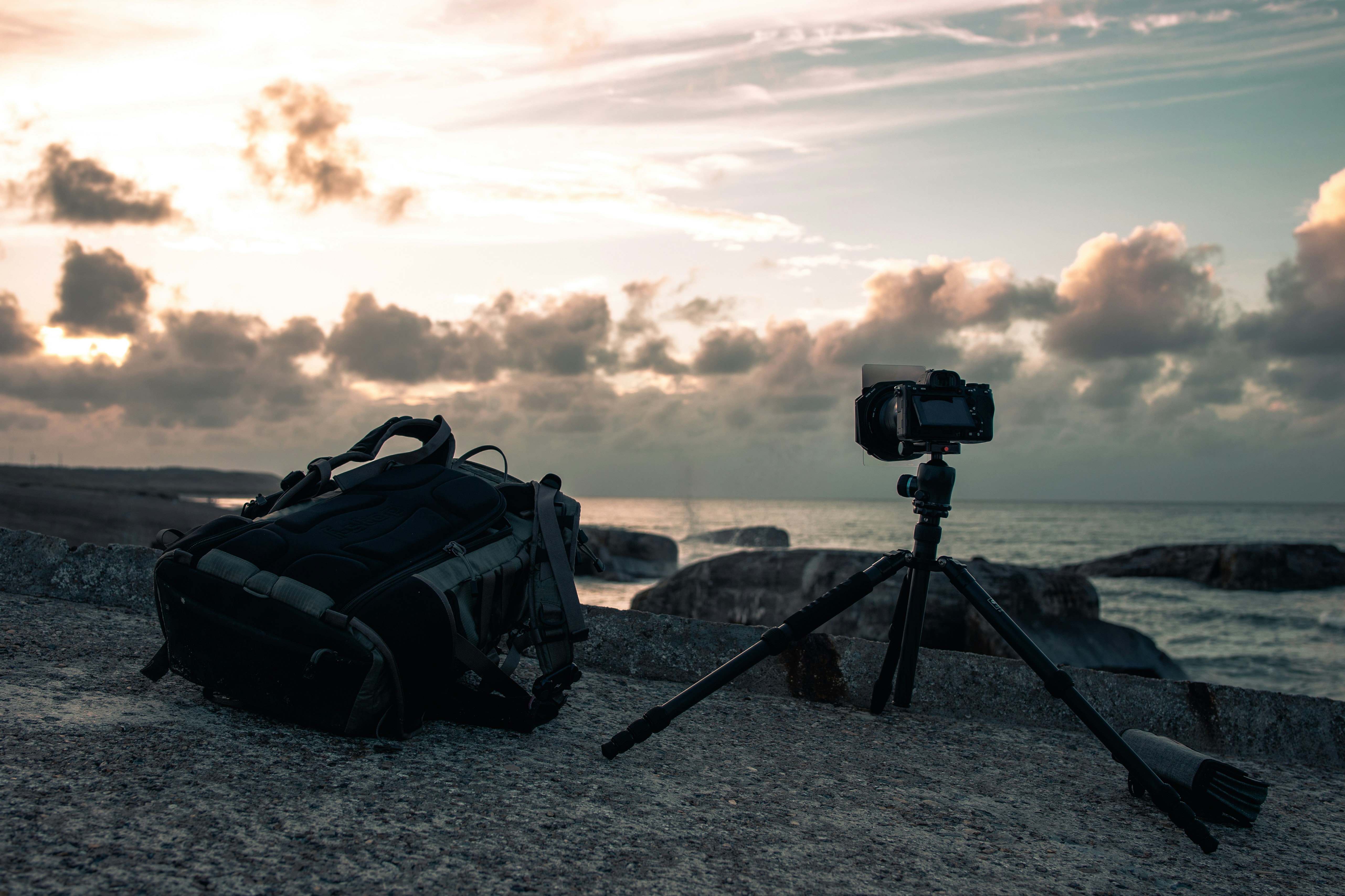 Dusk by the Rocks: Gear Resting on a Weathered Seaside