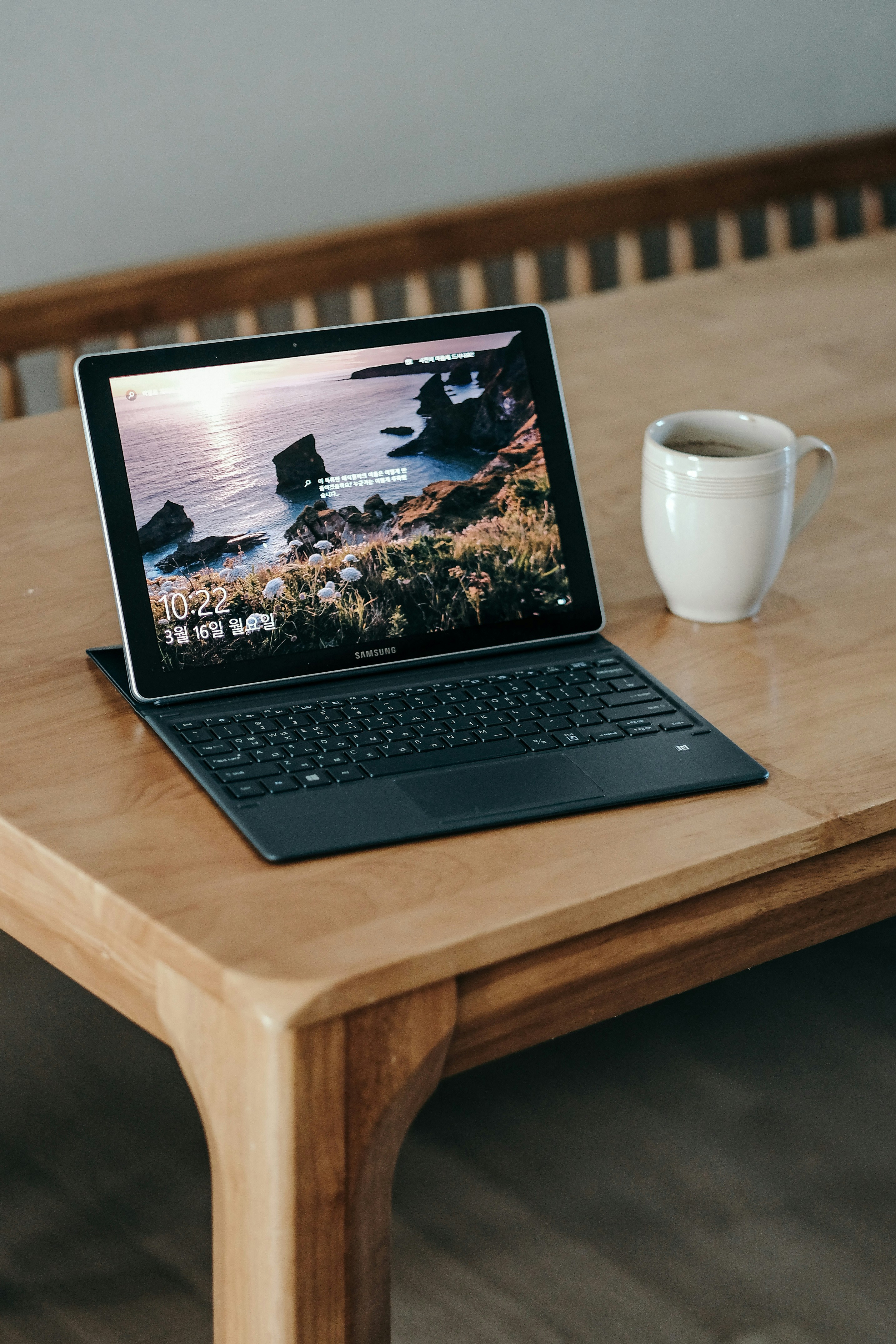 Cozy Workflow: Tablet Computer and Mug on Wooden Table