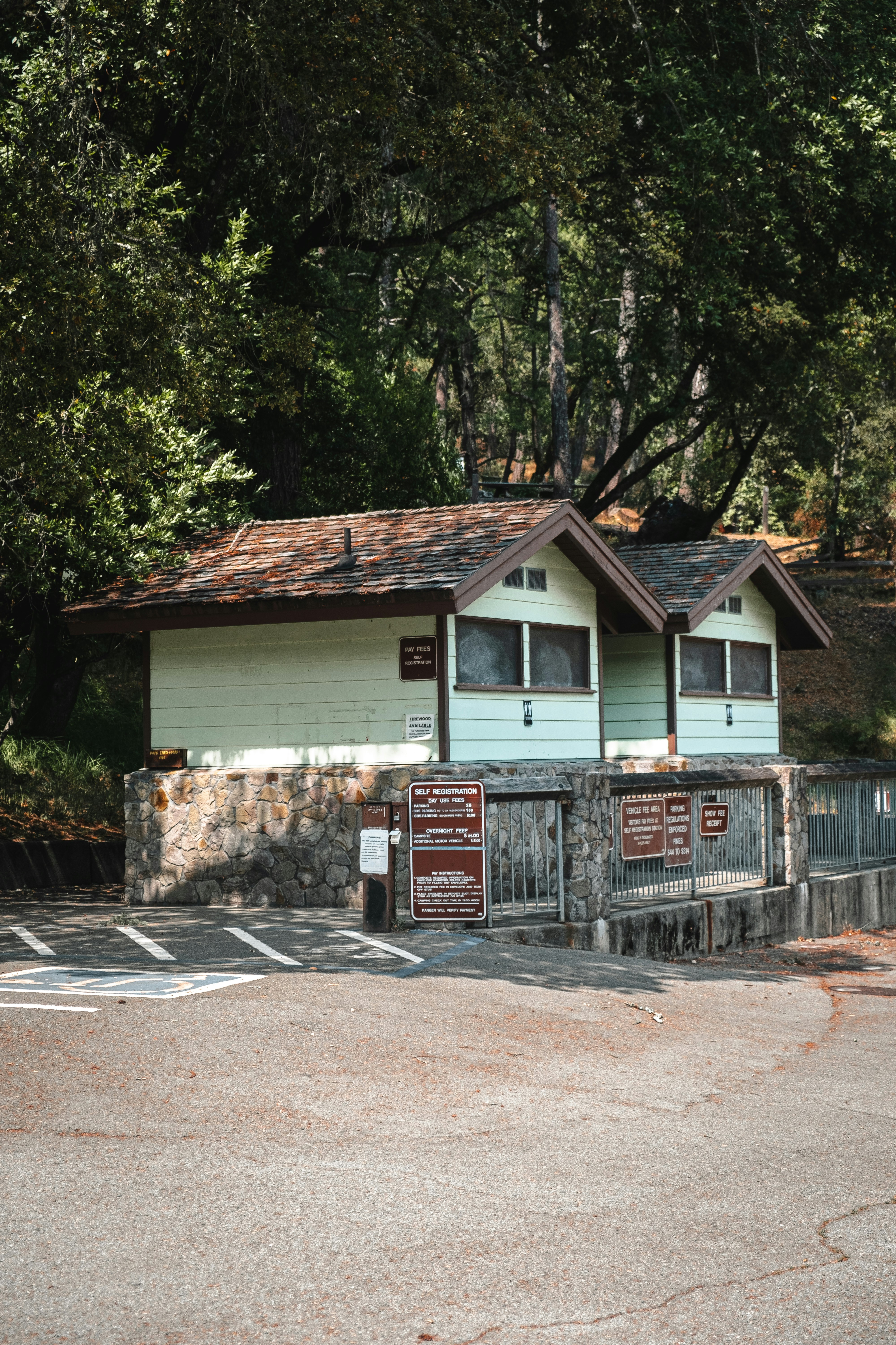 Pastel Gatehouse Duo Framed by a Weathered Stone Wall