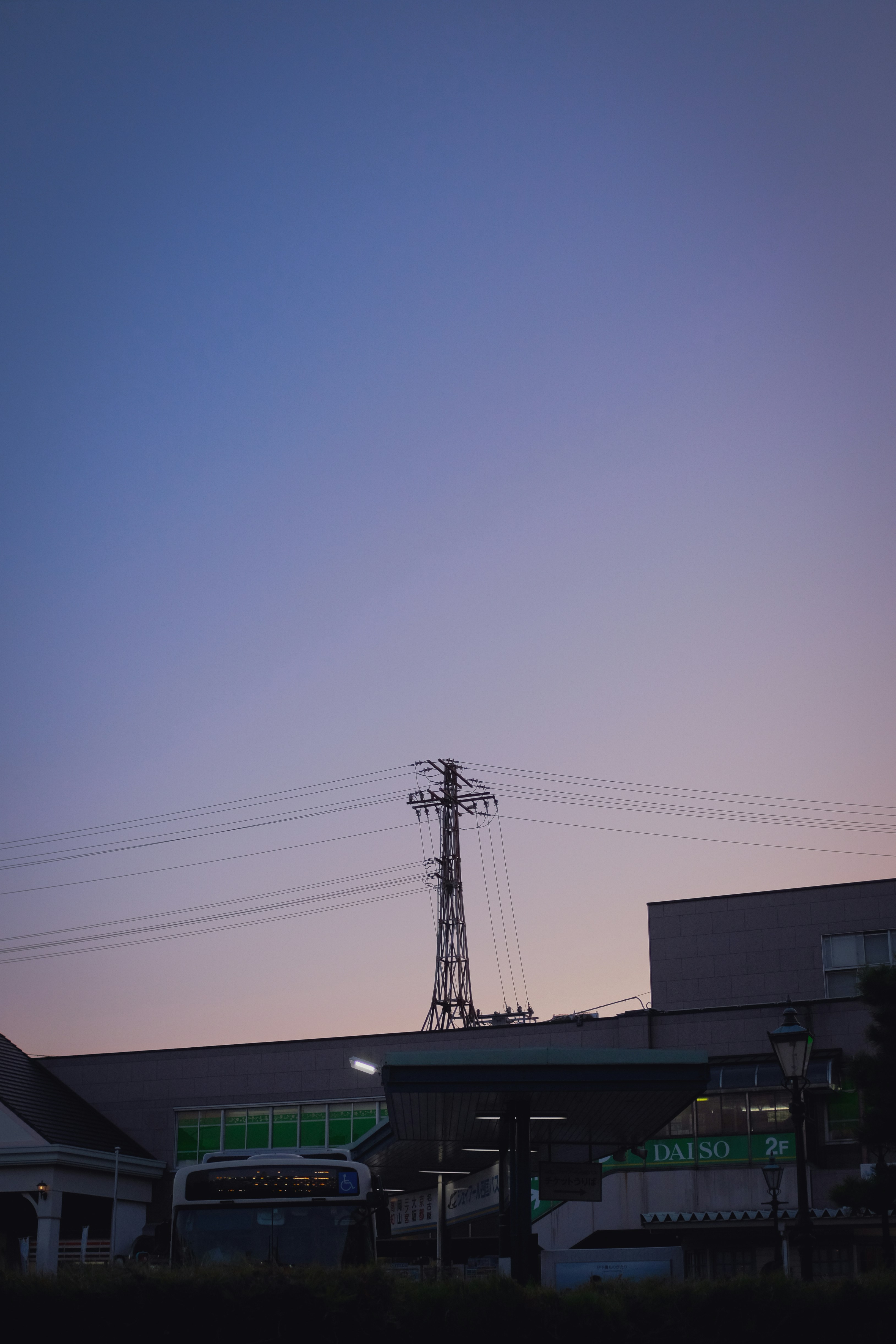 Dusk Grid: Silhouette of a Transmission Tower Against a Gradient Sky