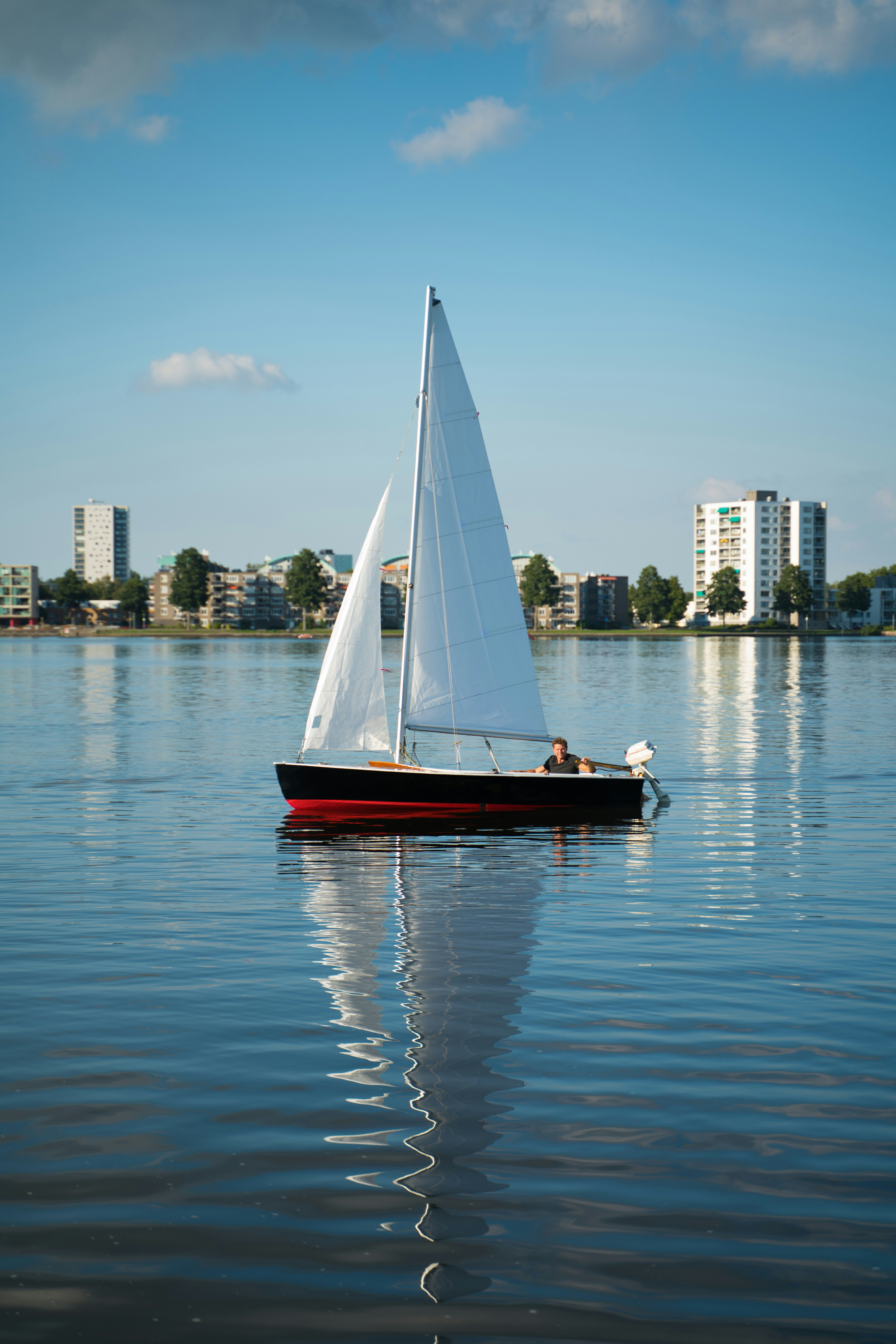Shot by @pieter_nijs | red and white boat on sea during daytime