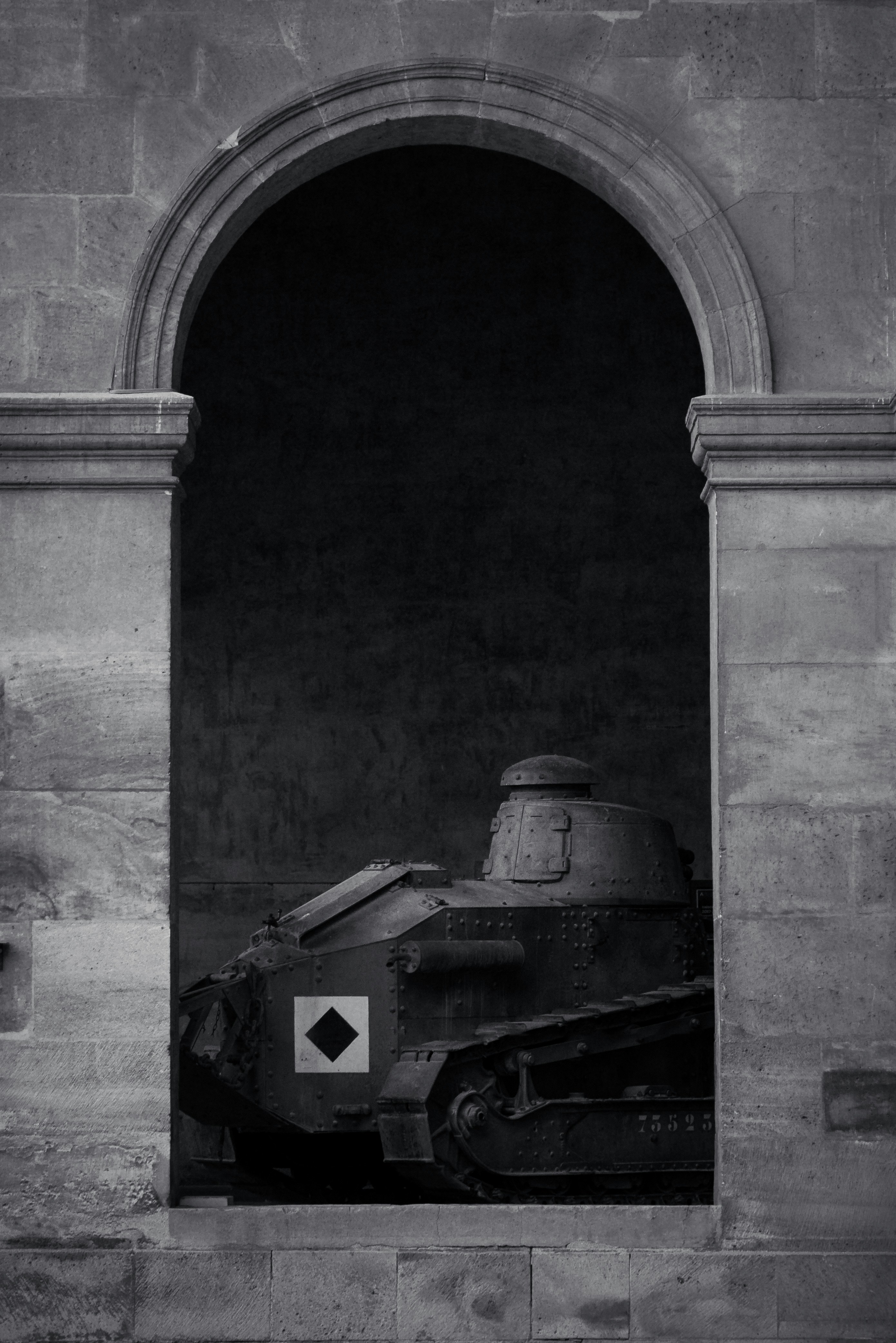 Archway Sentinel: A Tank Resting in a Shadowed Stone Portal