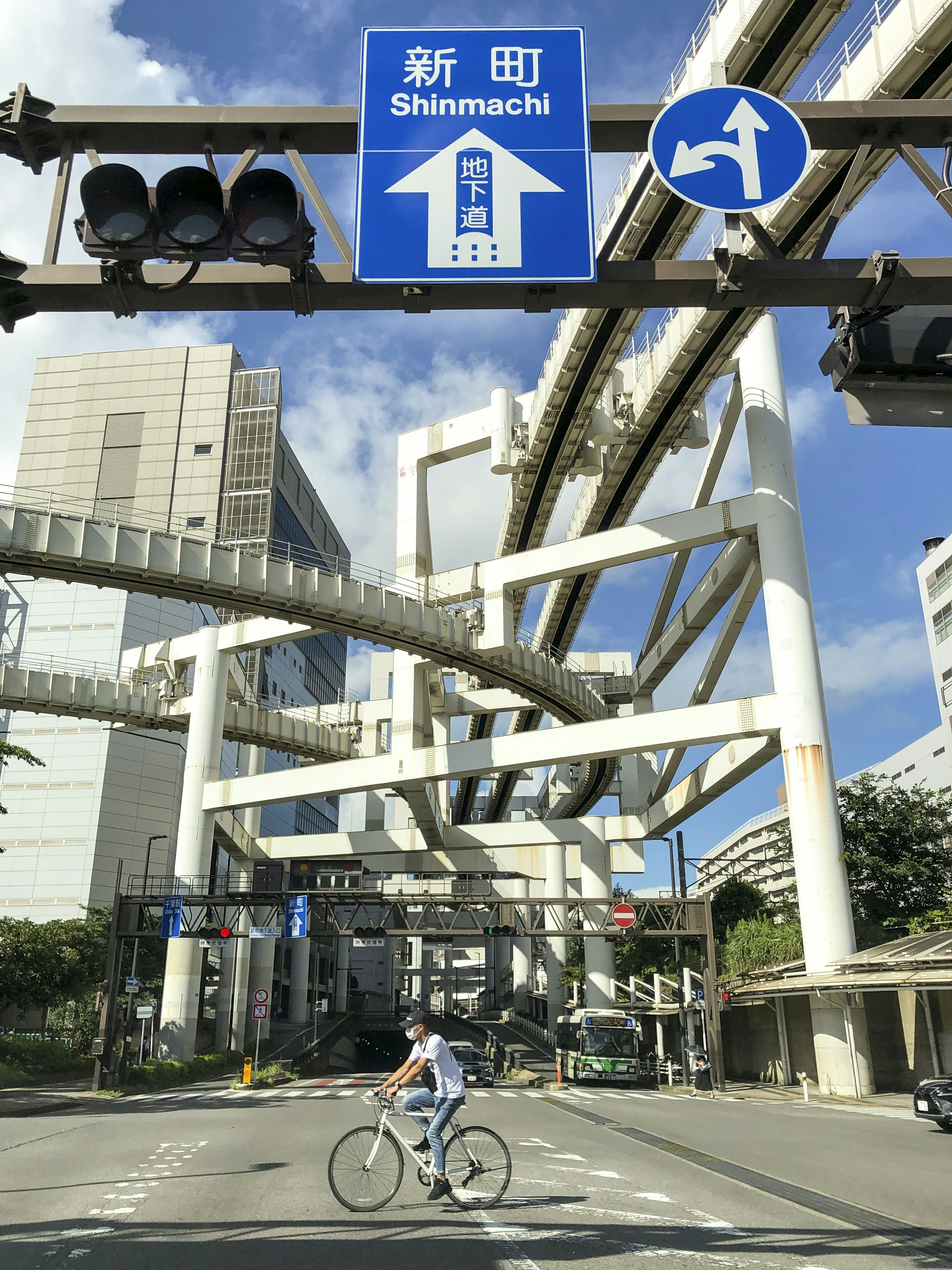Rider Beneath Shinmachi: Navigating a Skyward Network of White Steel