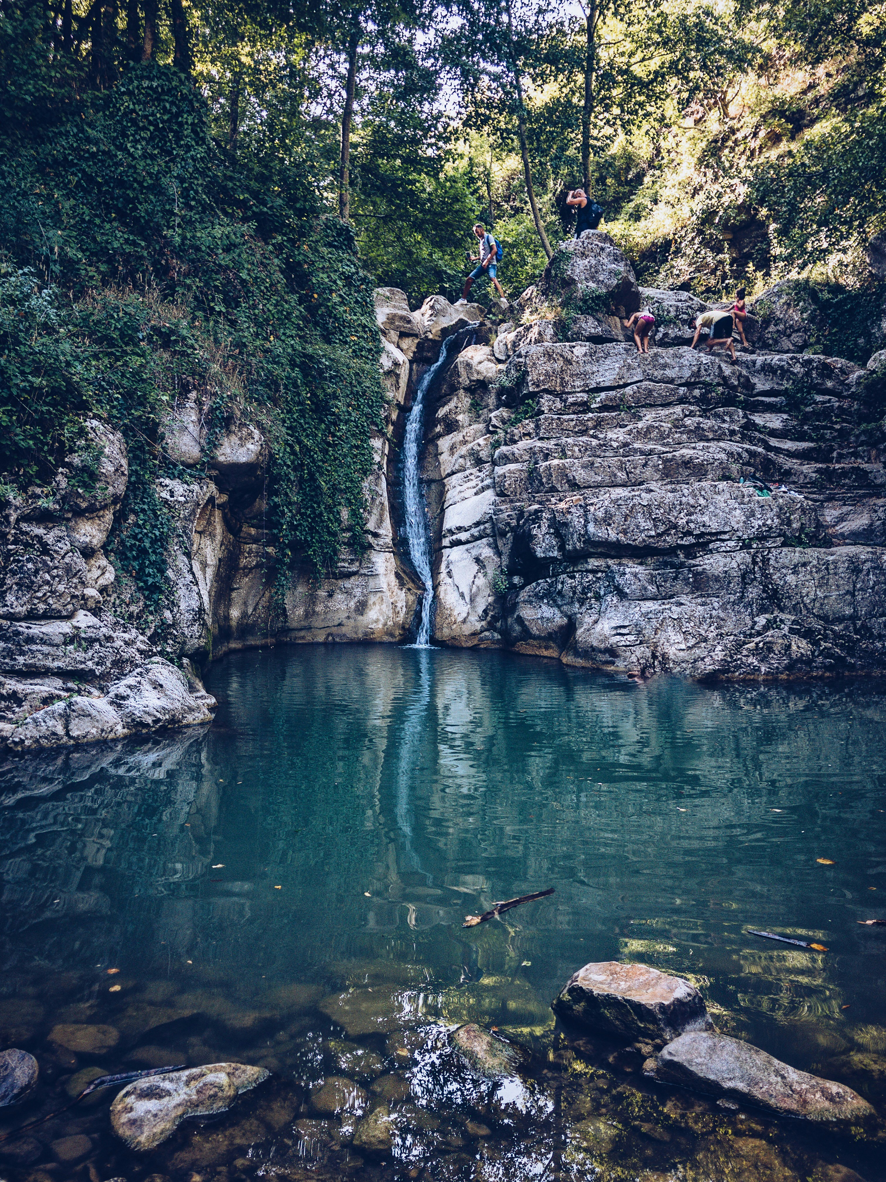 Cliffside Cascade Over a Turquoise Pool