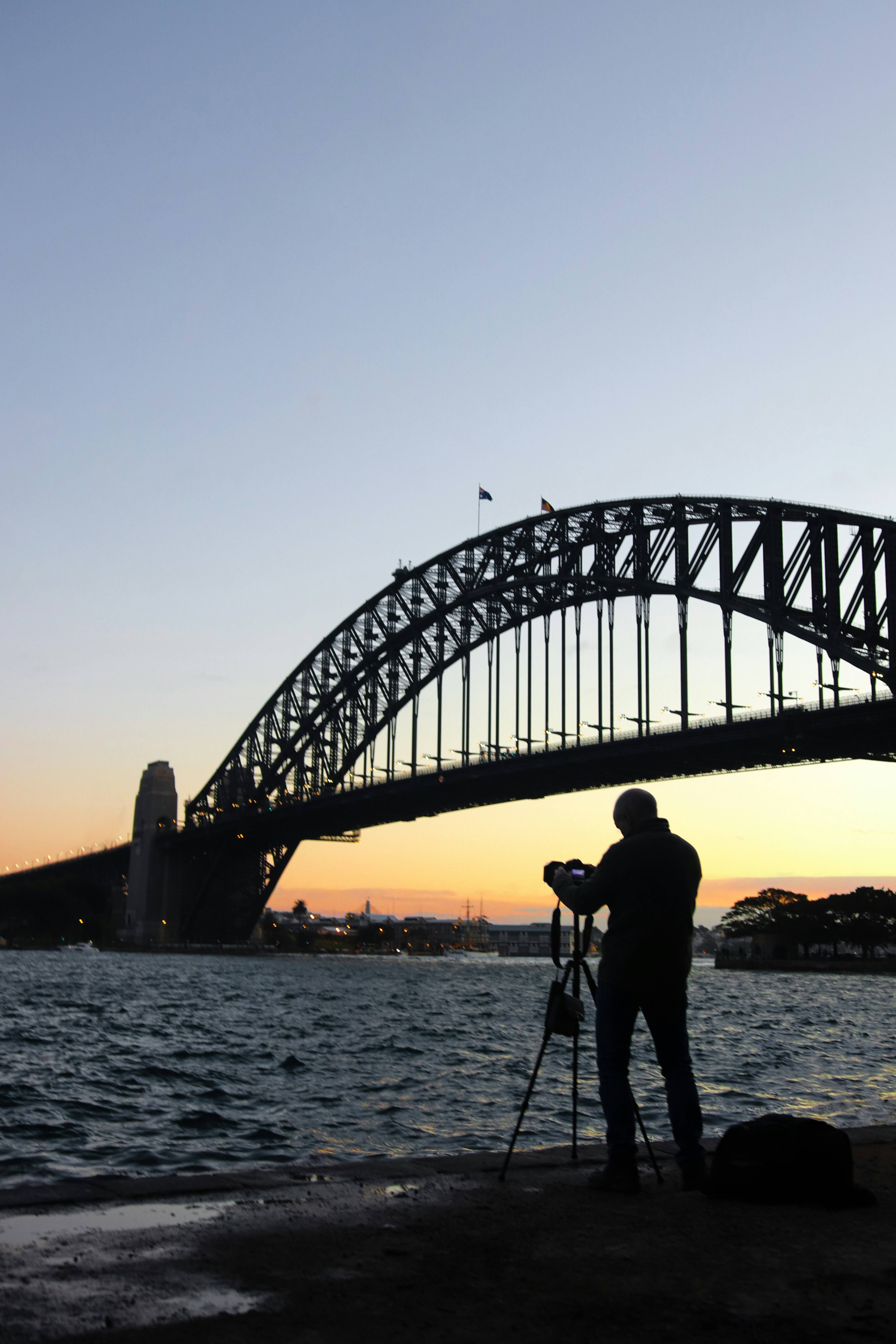 Silhouette of man standing on bridge during sunset photo – Free ...
