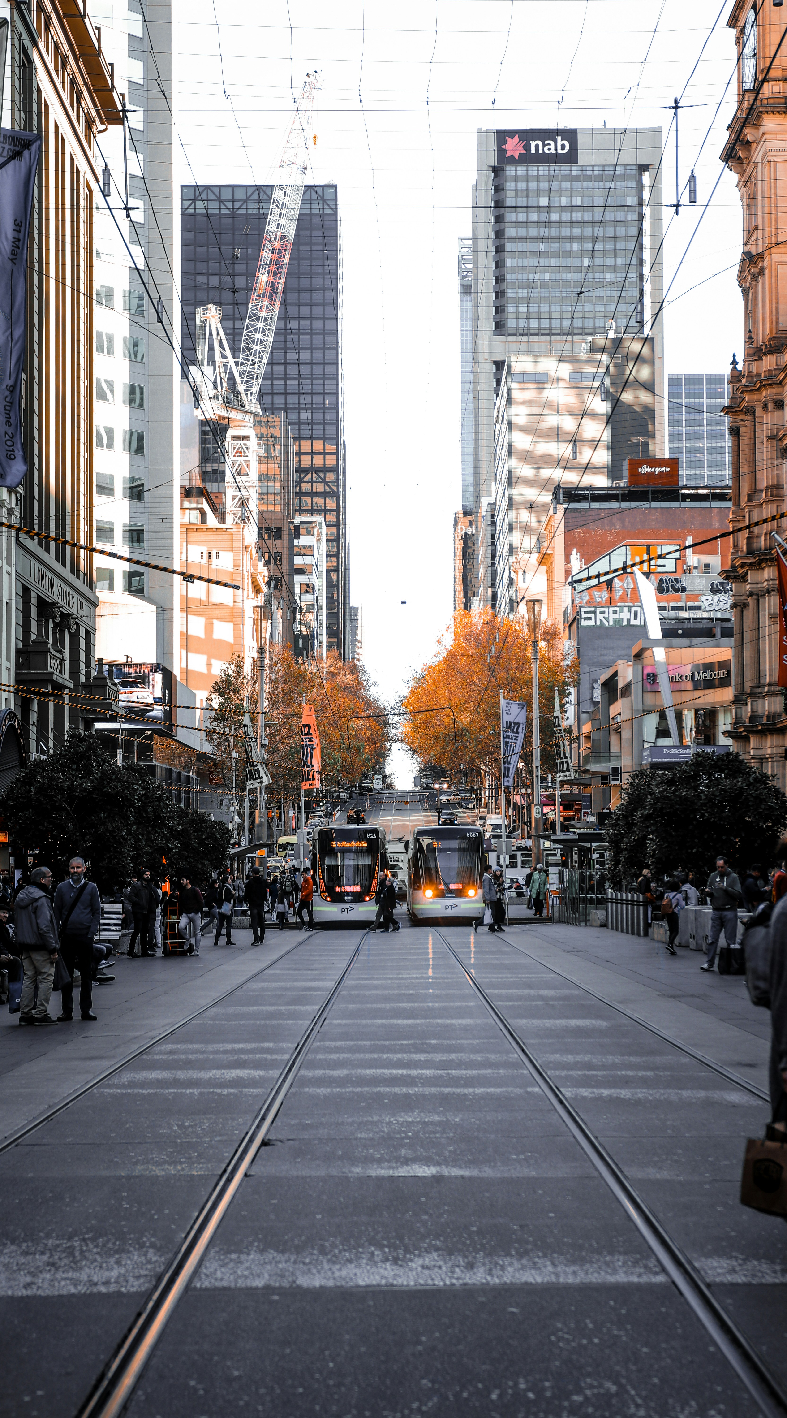 People walking on sidewalk near high rise buildings during daytime ...