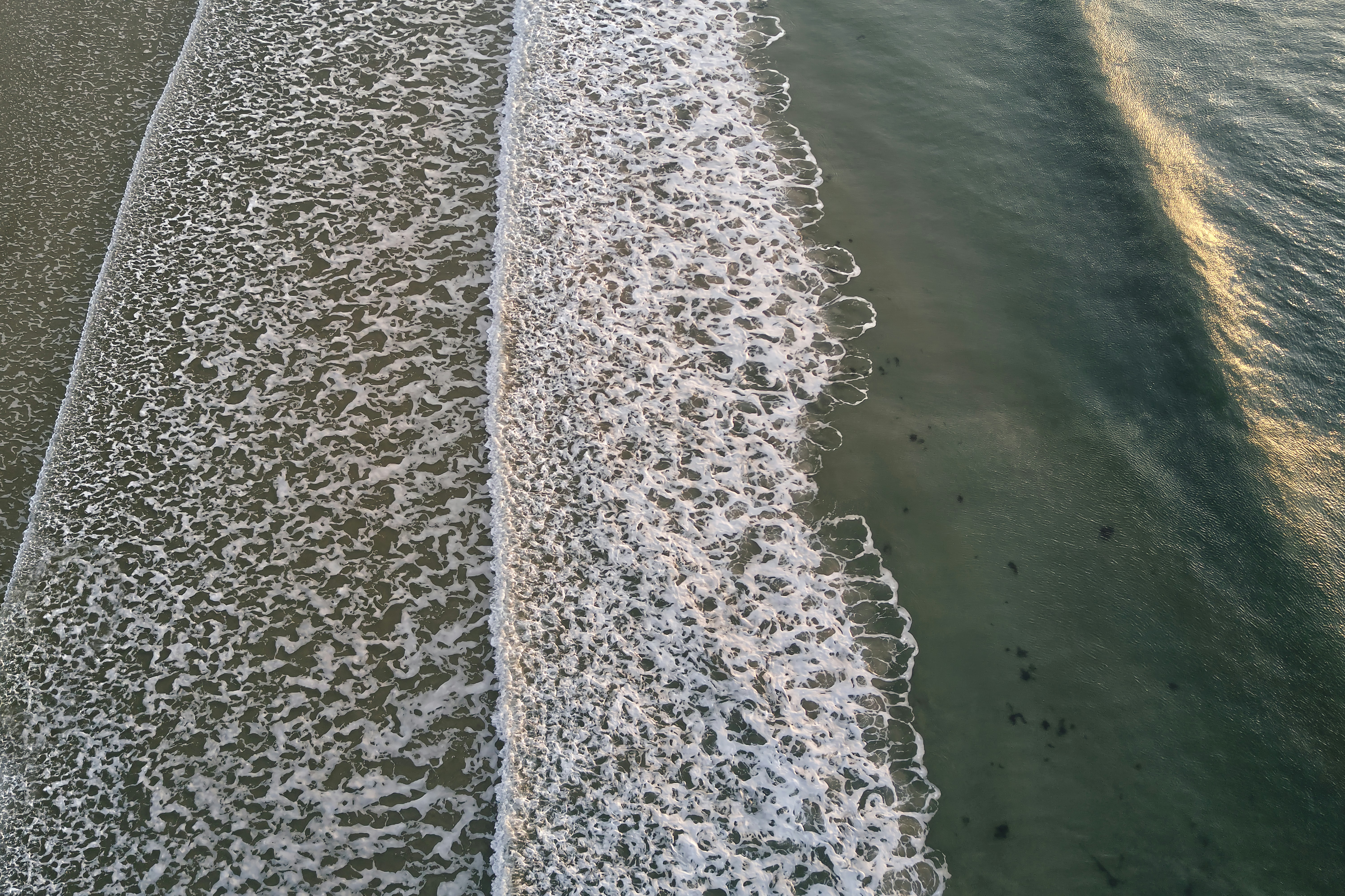 Foam Ribbon over the Shore: An Aerial Study of Coastal Geometry