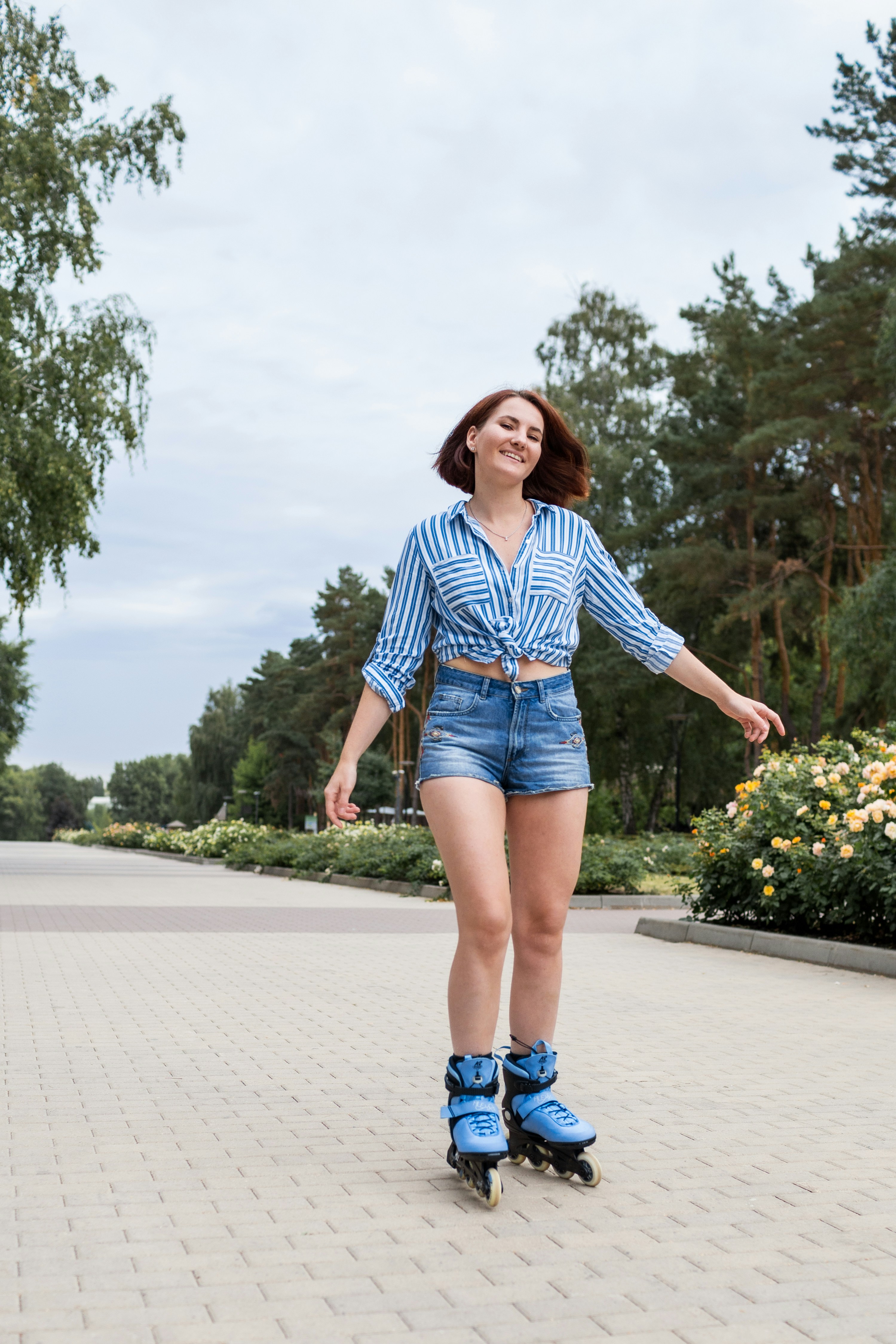 Blue Stripes, Bright Skies: A Joyful Rollerblade Moment in the Park