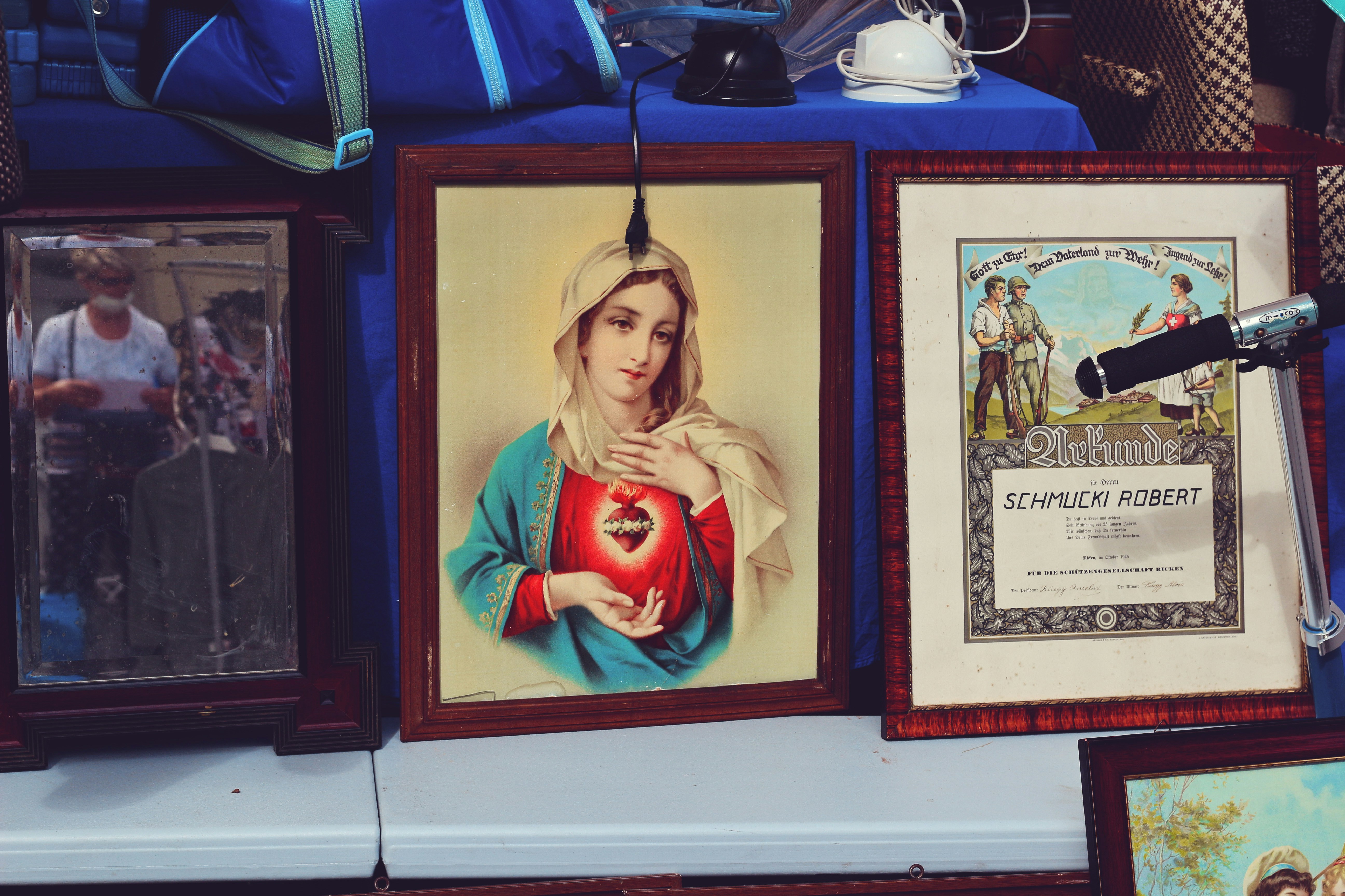 Madonna with Heart: Framed Reverence Amid Street Market Treasures