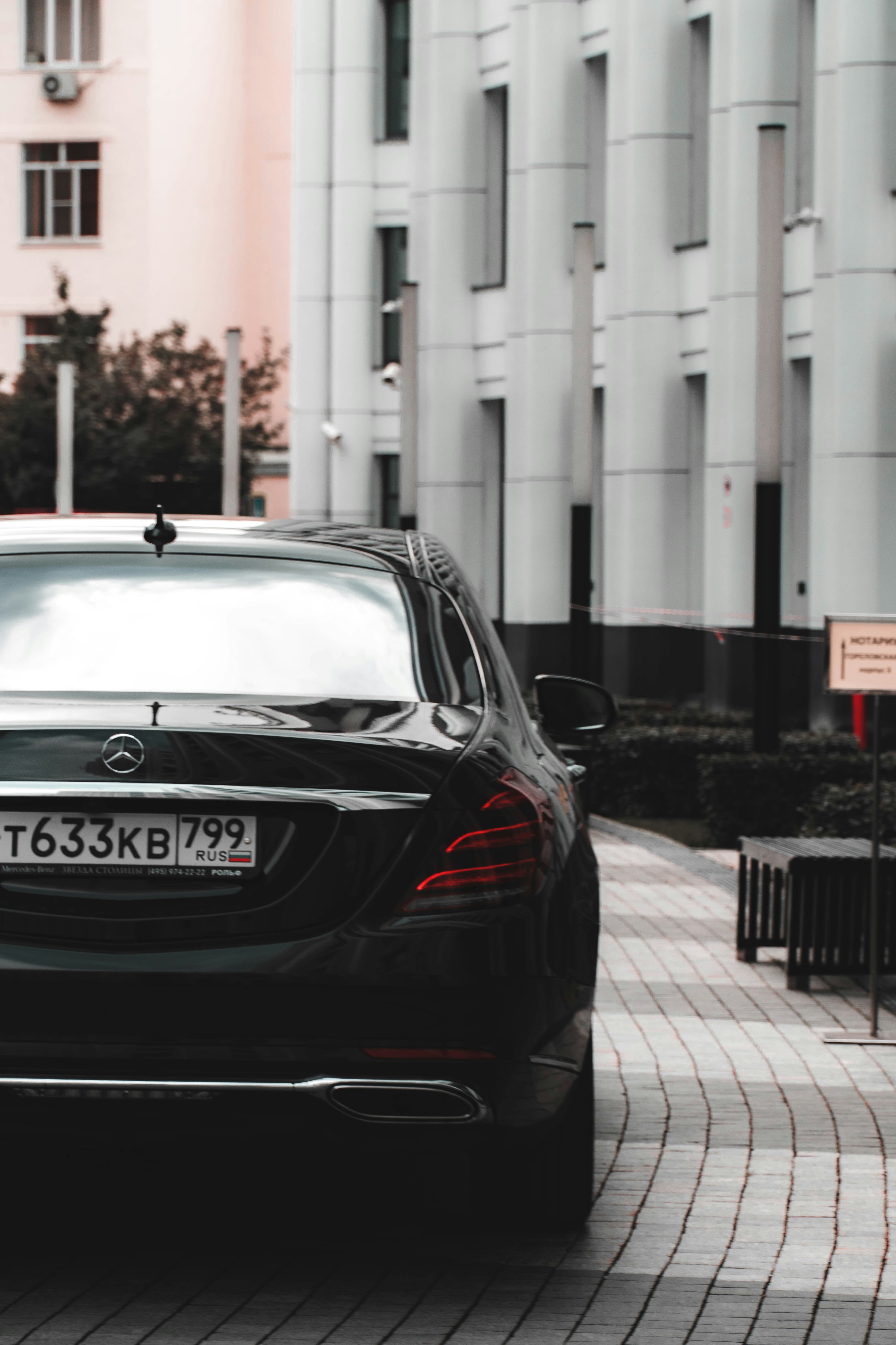 Rear View in a Modern Courtyard: A Black Mercedes at Dusk