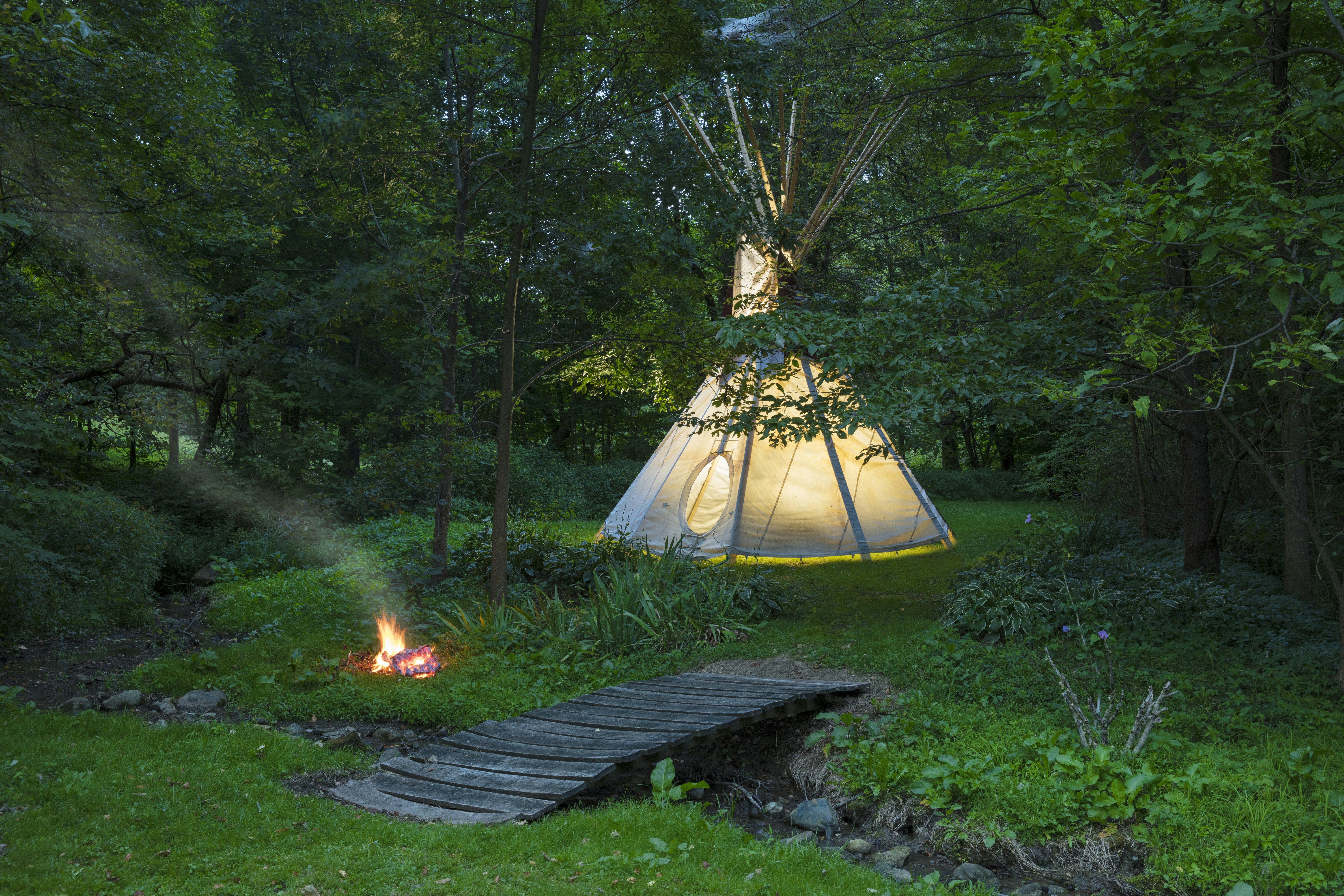 I lived three years in this tipi in northern Ohio.  Here is it without the inner liner, a cool summer set.