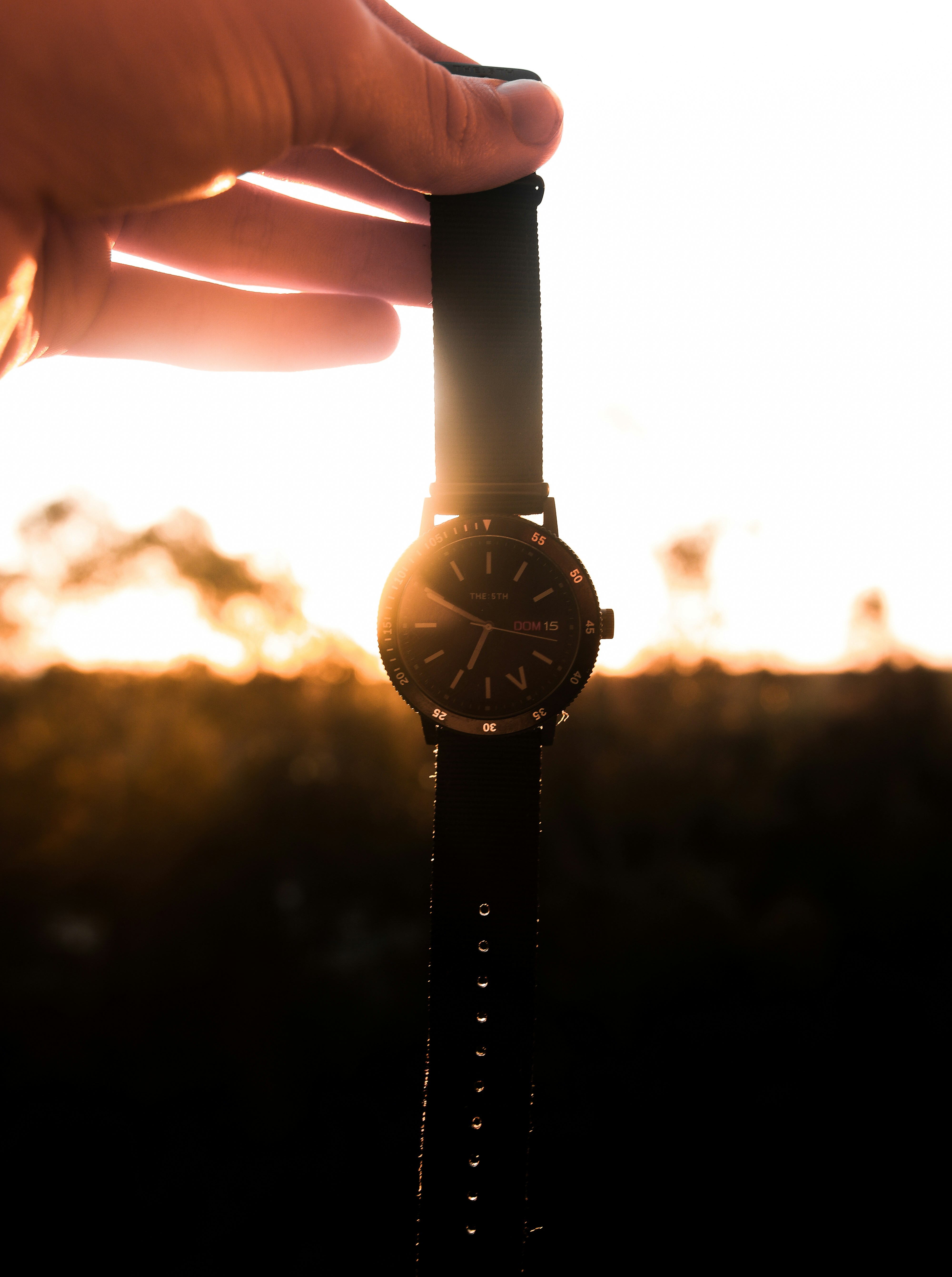person holding black and gold analog watch