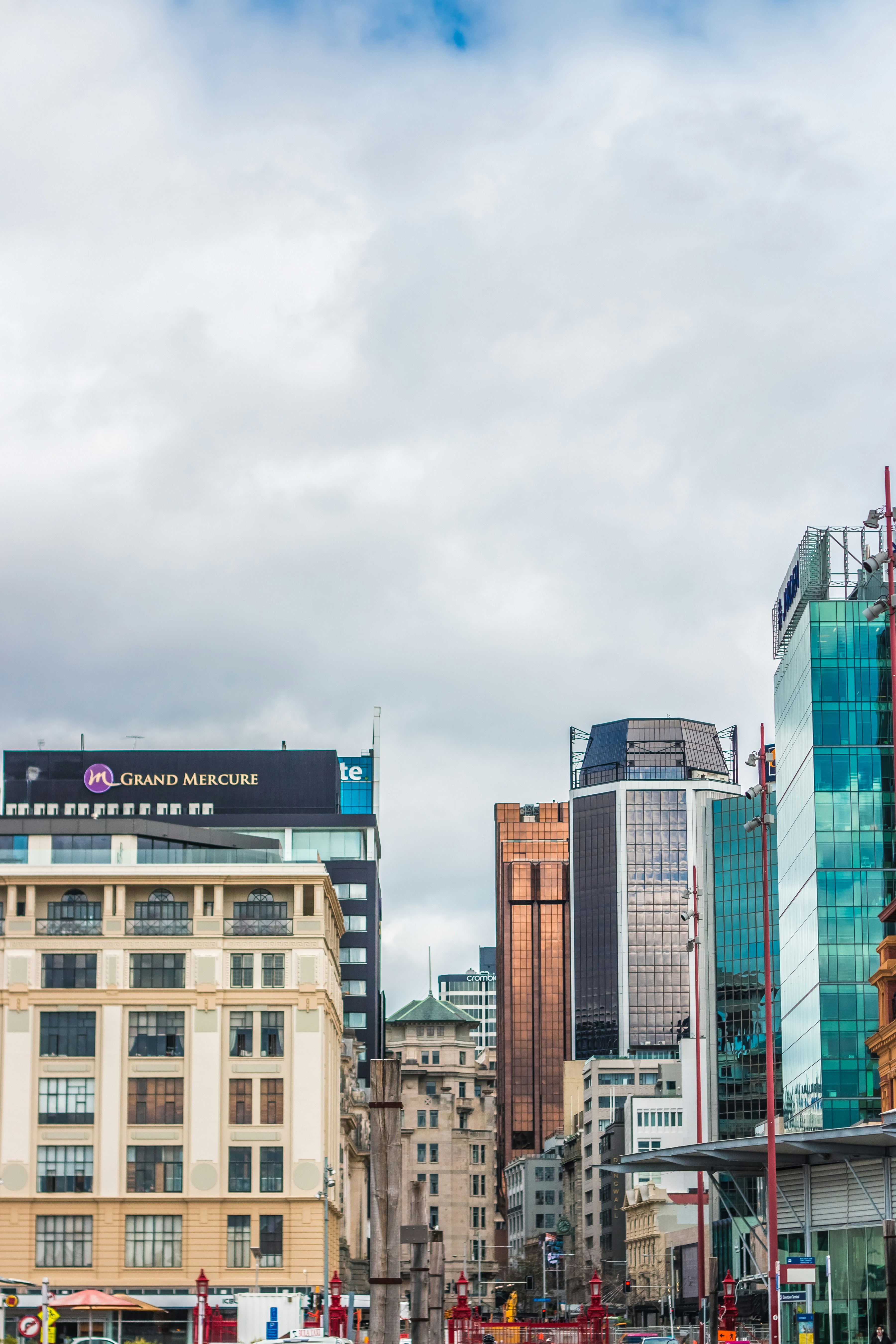 Modern skyscrapers and historic buildings coexist in a vibrant cityscape, showcasing architectural diversity and urban life.