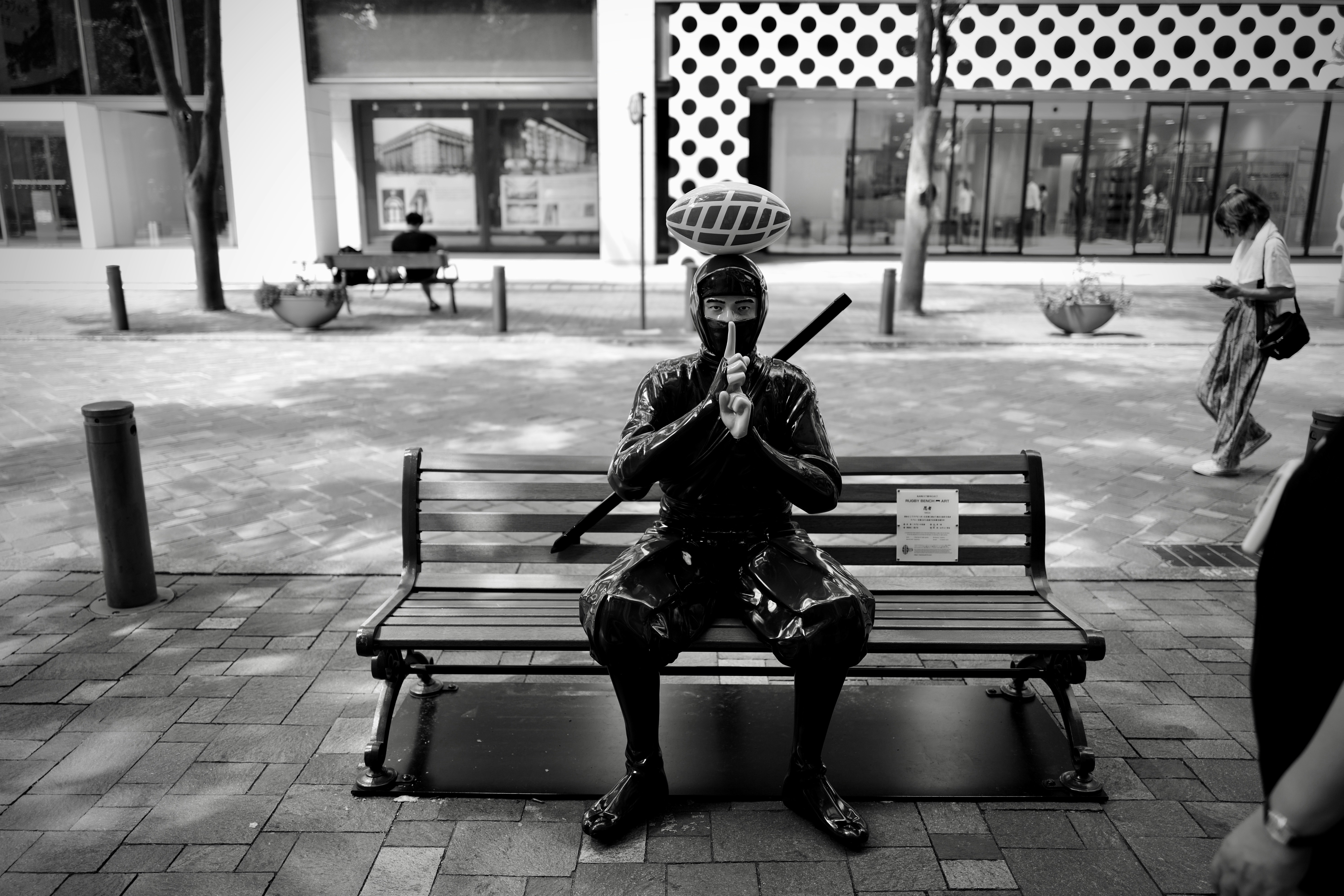 Benchside Warrior: a masked performer with a prop sword