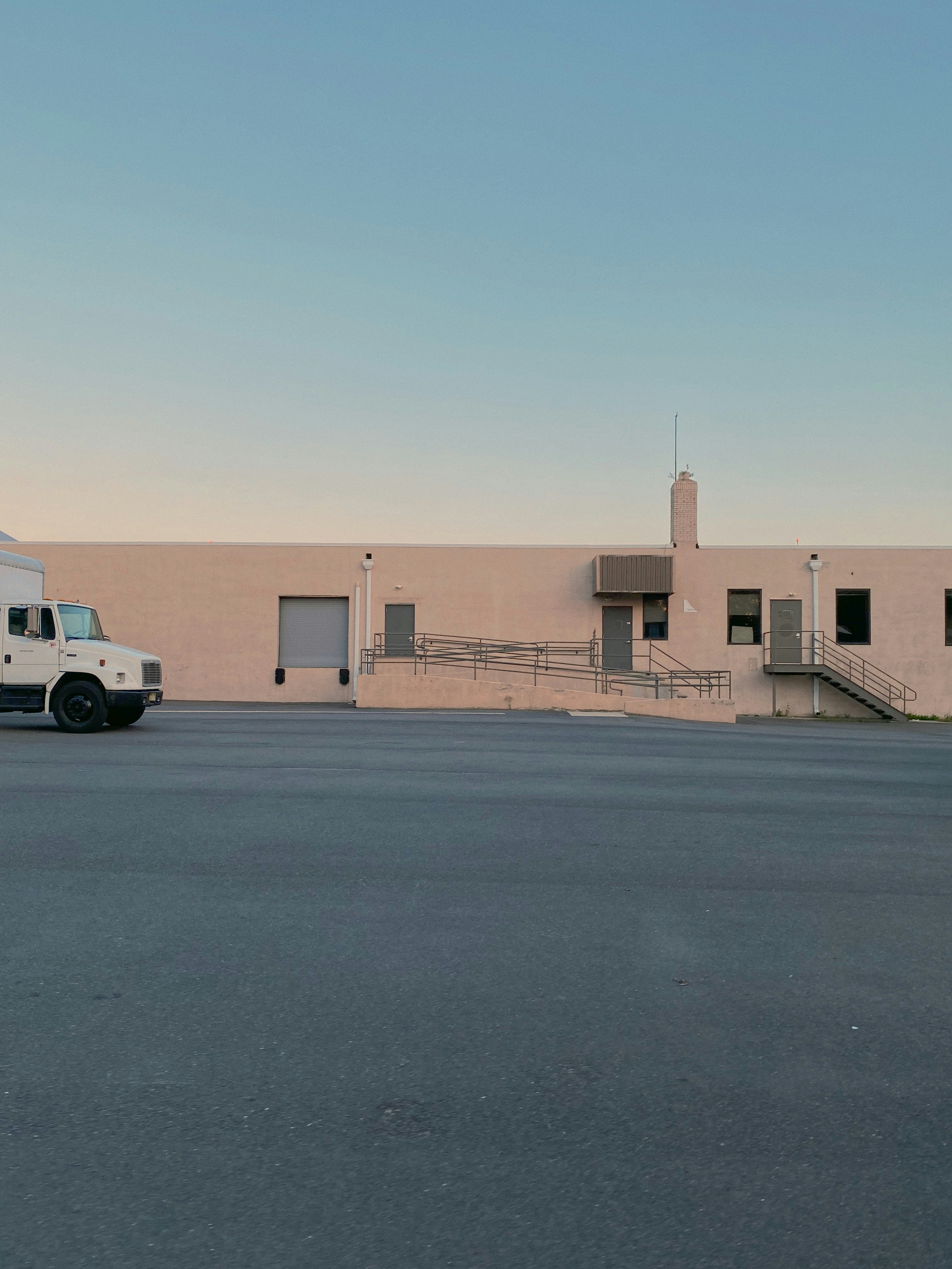 Pastel Dawn Over a Quiet Industrial Loading Yard