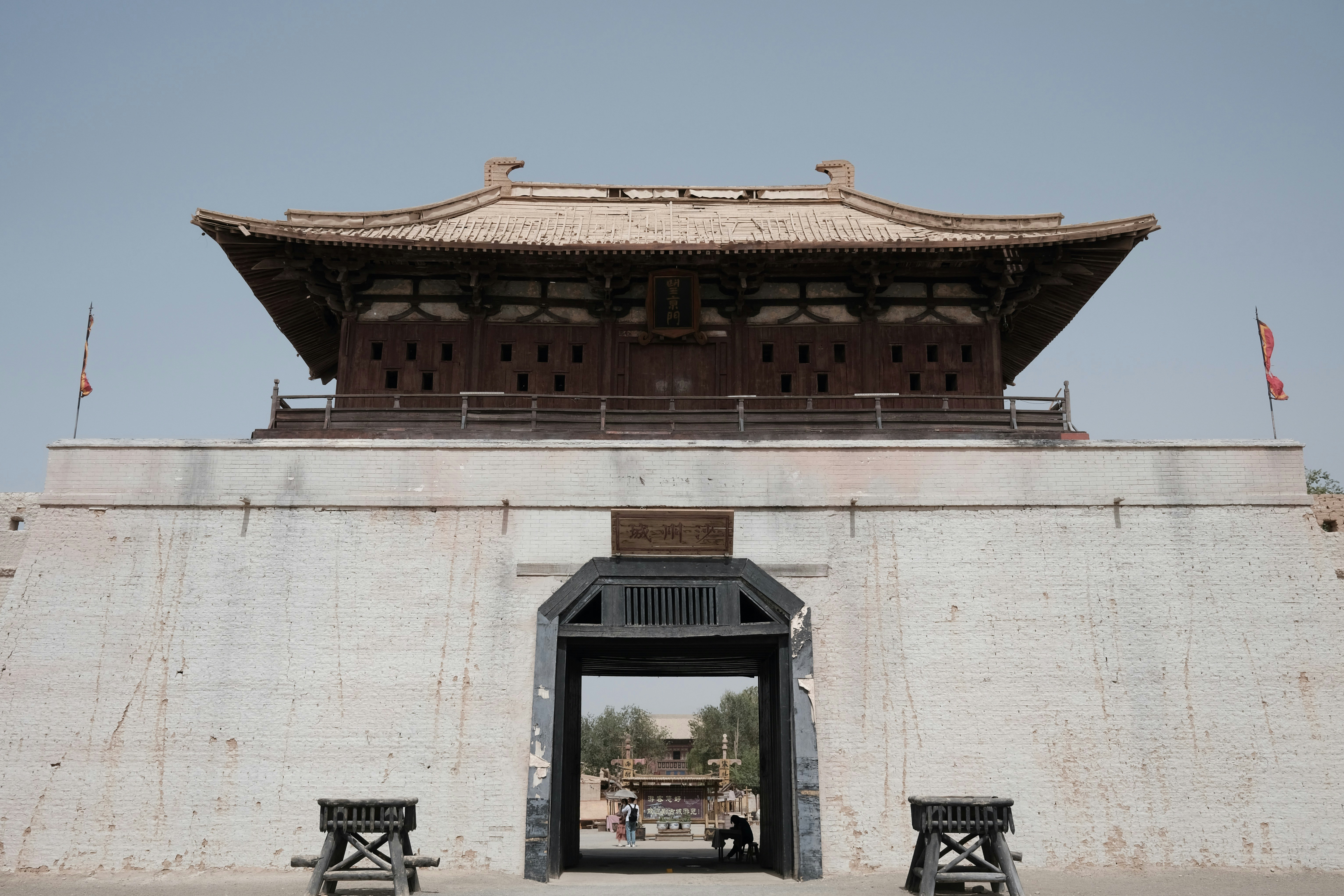 Historic architectural structure with a grand entrance, showcasing traditional design elements and surrounding scenery.