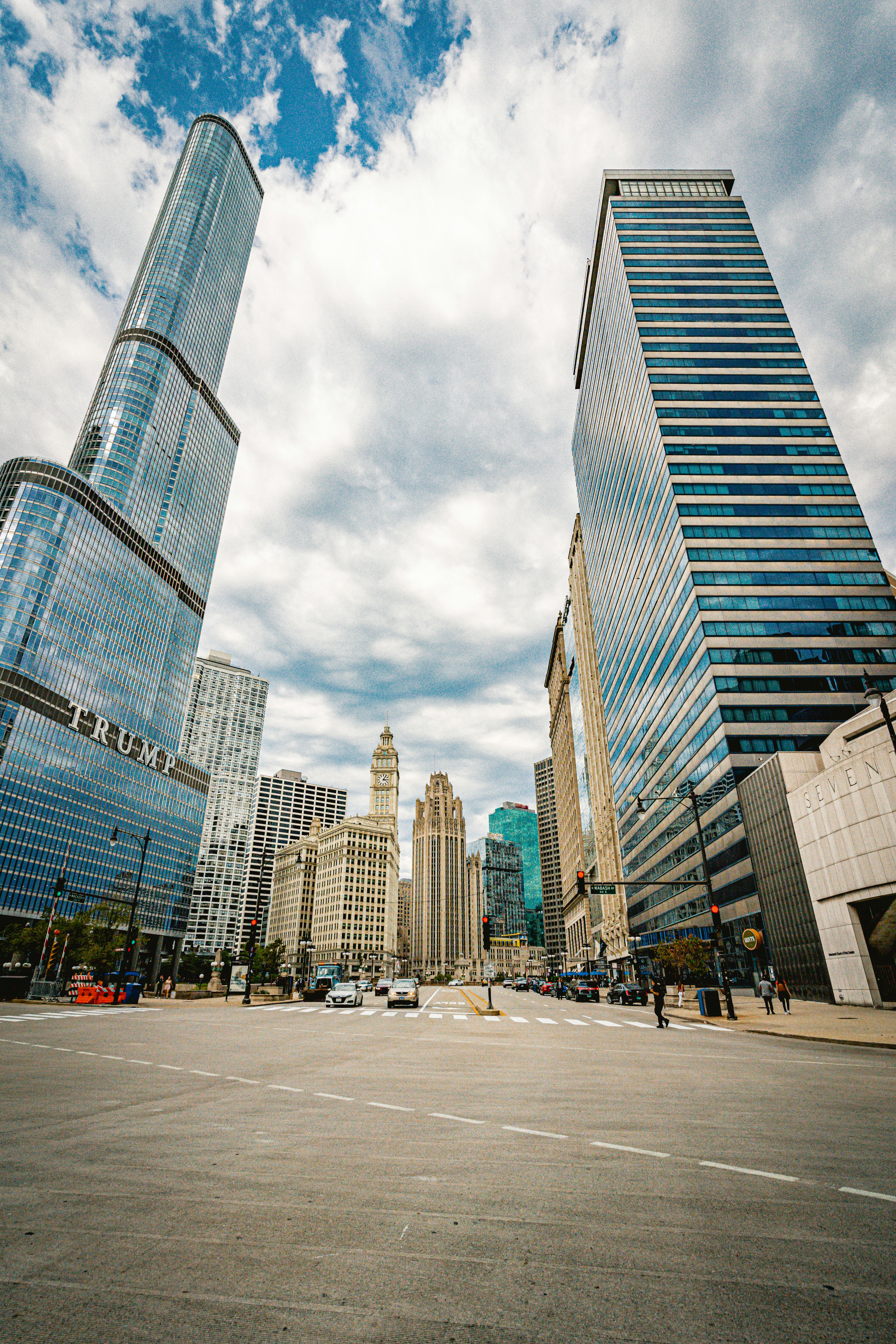 People walking on pedestrian lane near high rise buildings during ...