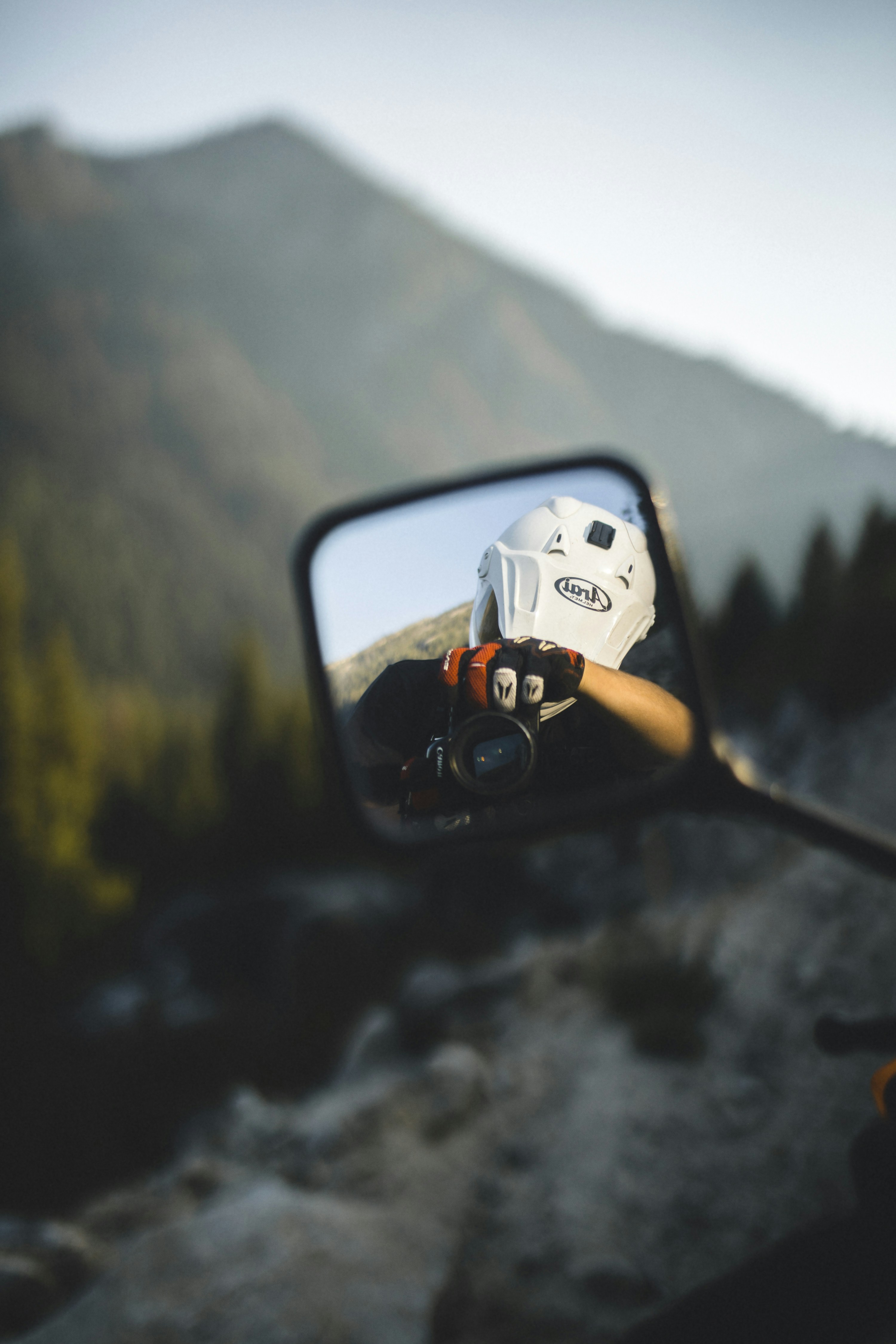 Glint of Focus: The Rider's Helmet in the Mirror