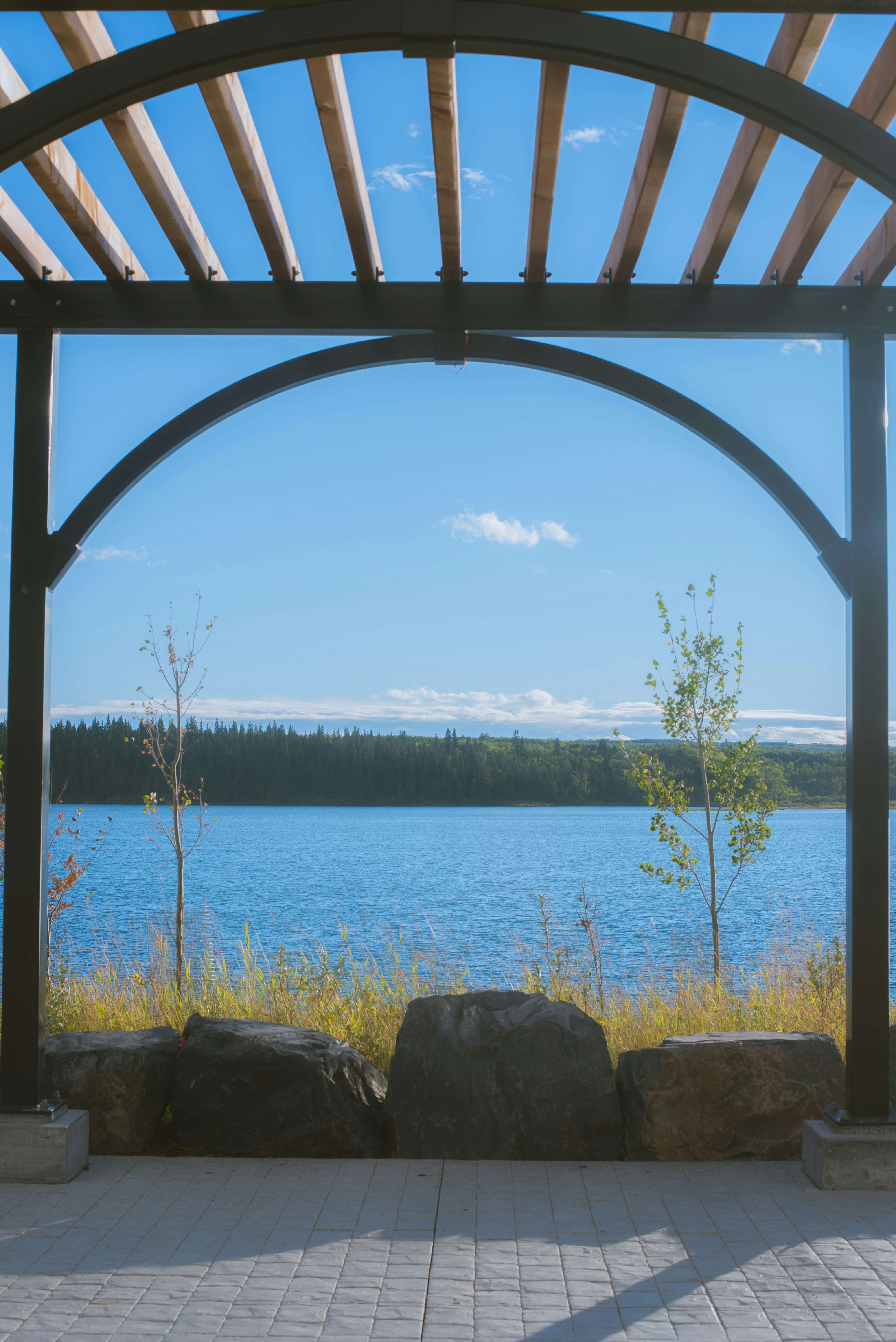 Timber-Arch Framing a Quiet Lakeside Vista