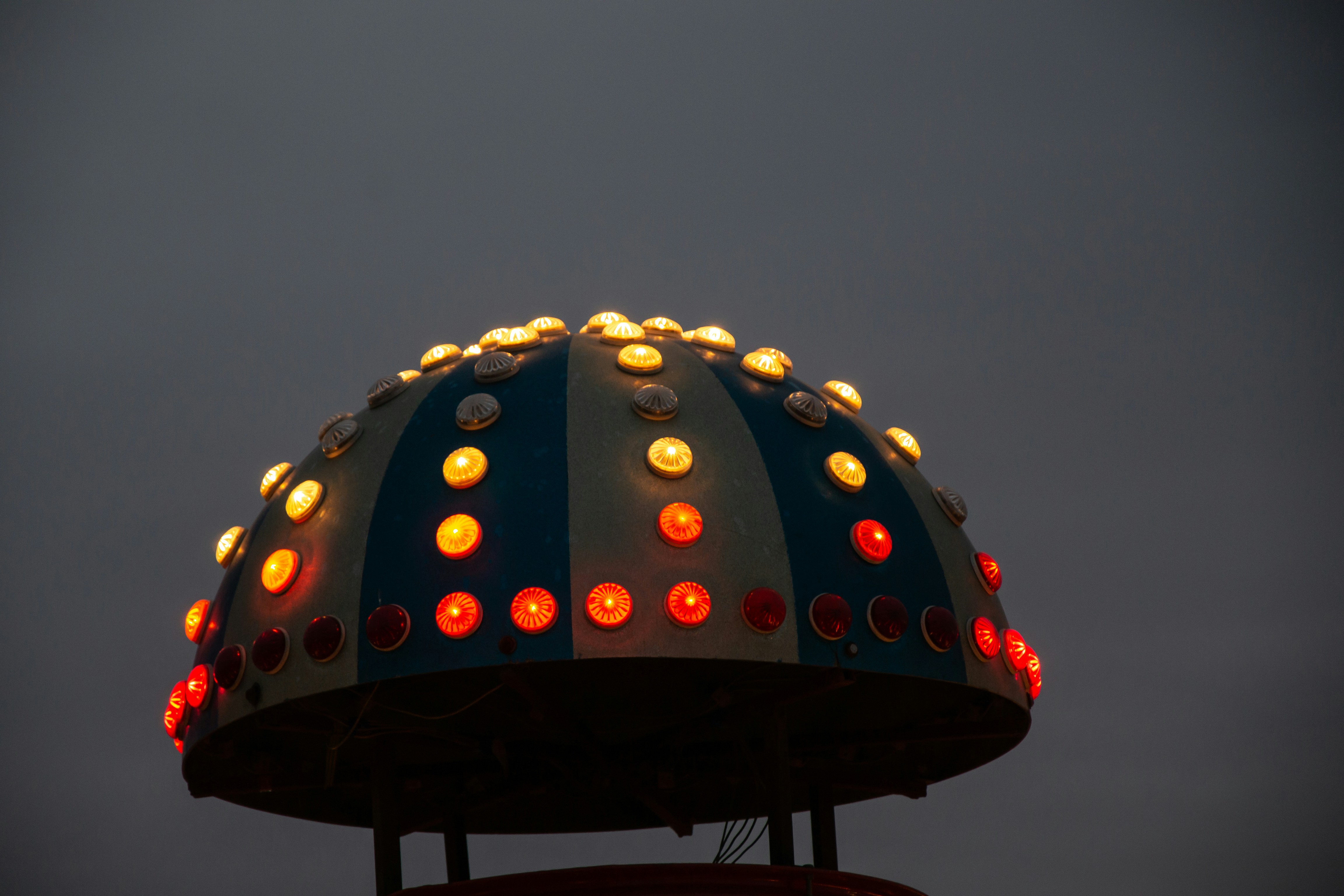 Neon Crown on a Carnival Dome: Orbs of Light in a Dusky Sky