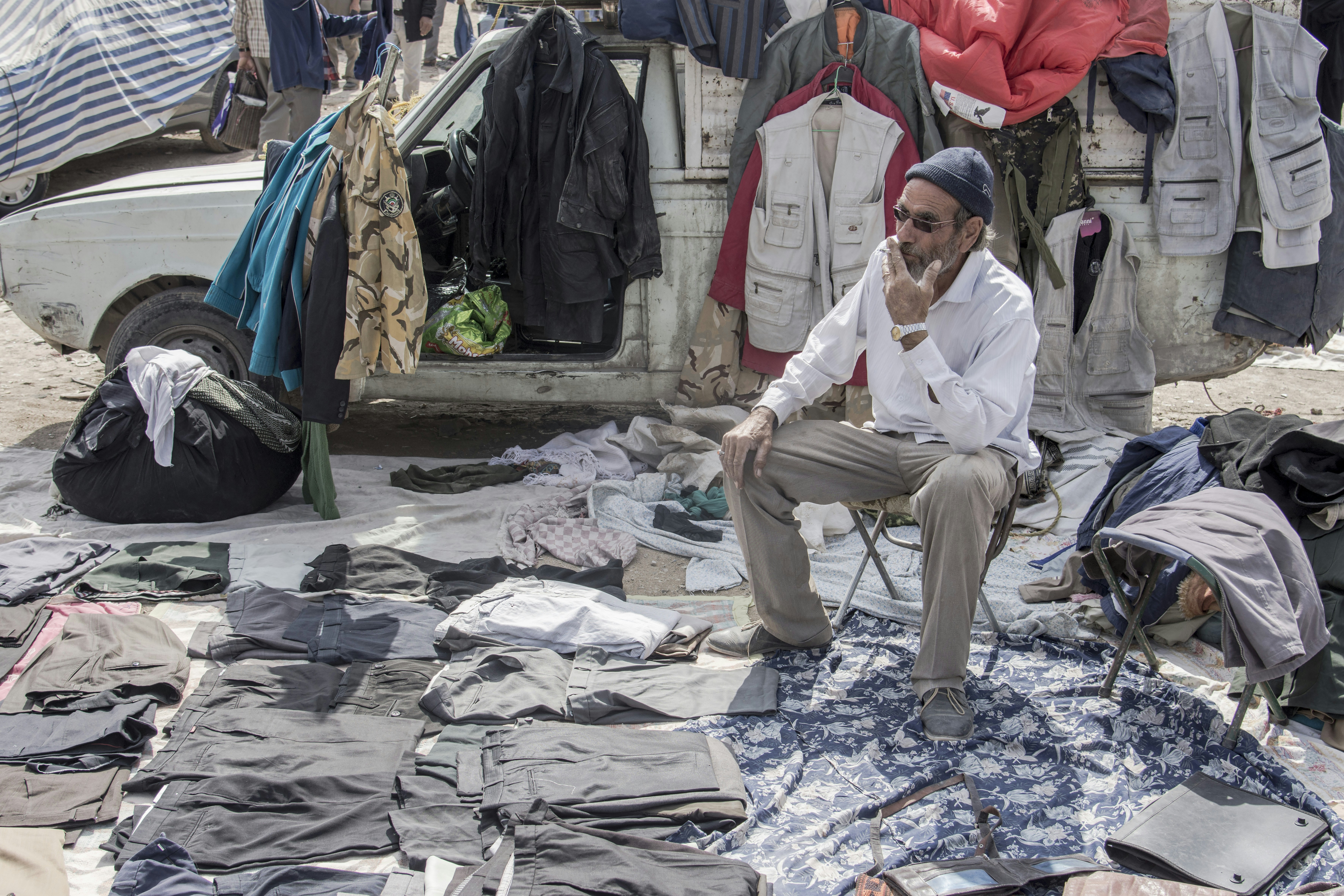 Patchwork Pause: A Street Vendor Weighs the Market