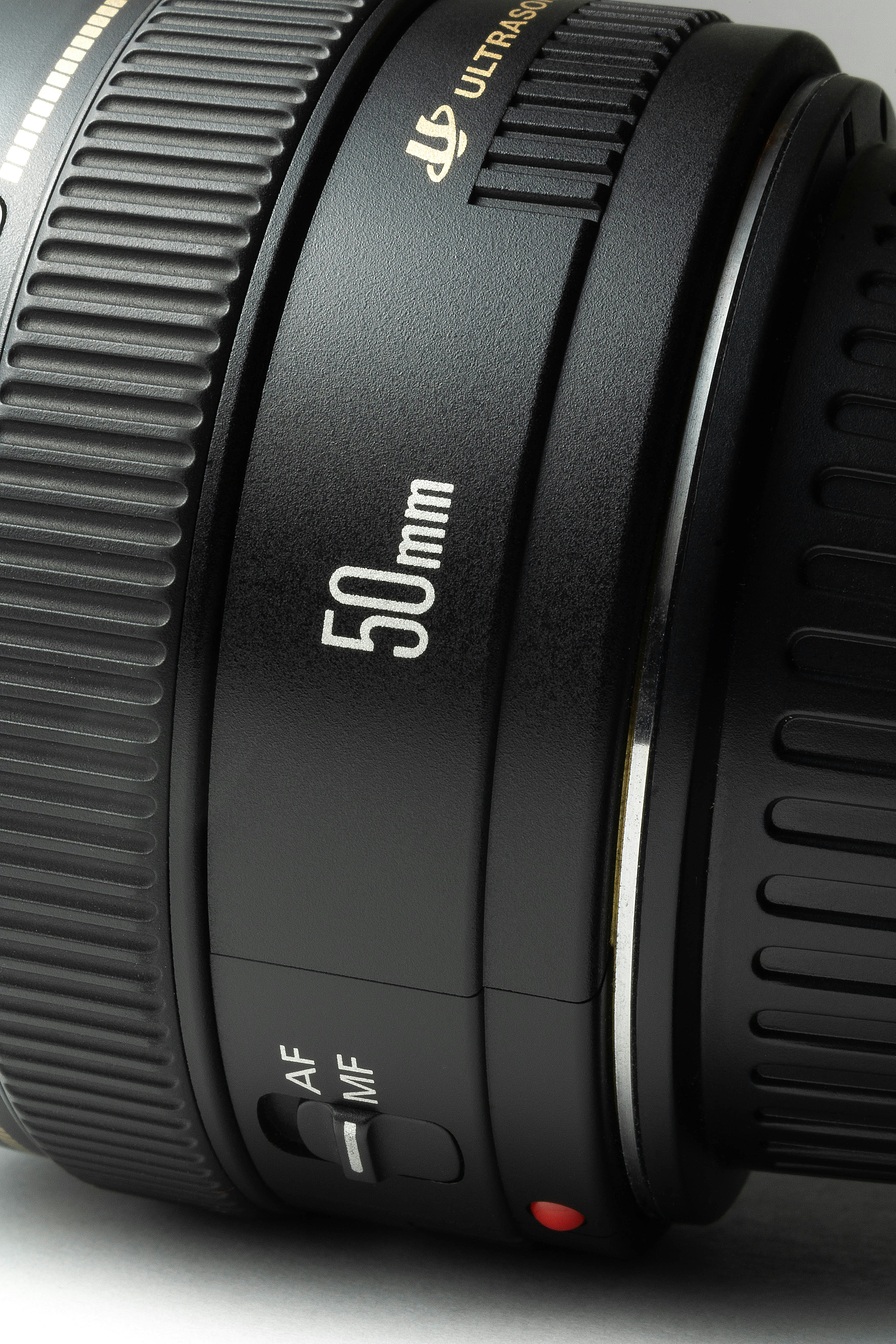 Close-up of a 50mm lens focus ring: precision and texture