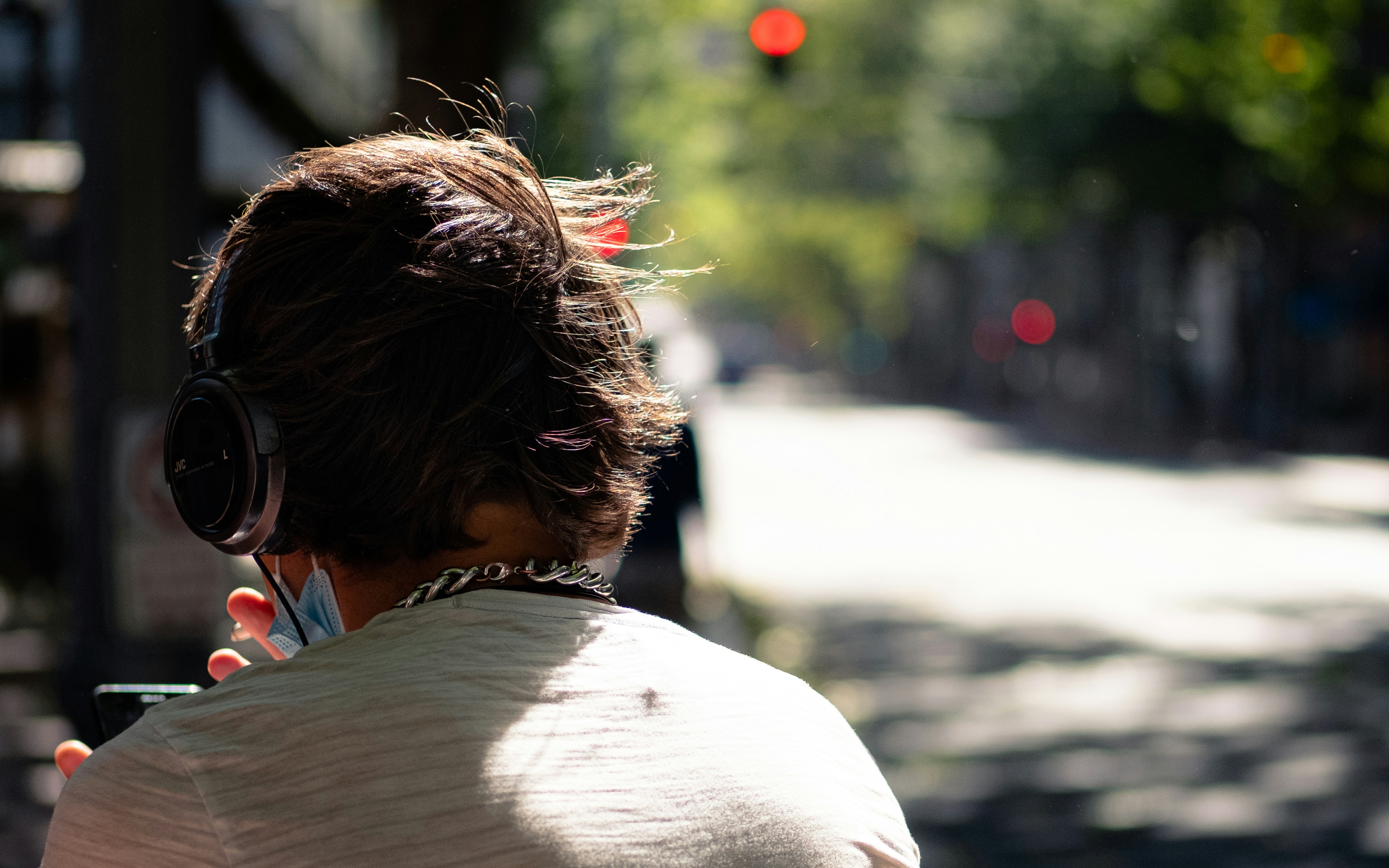 Back-View in the Sun: A Quiet Street Portrait with Headphones