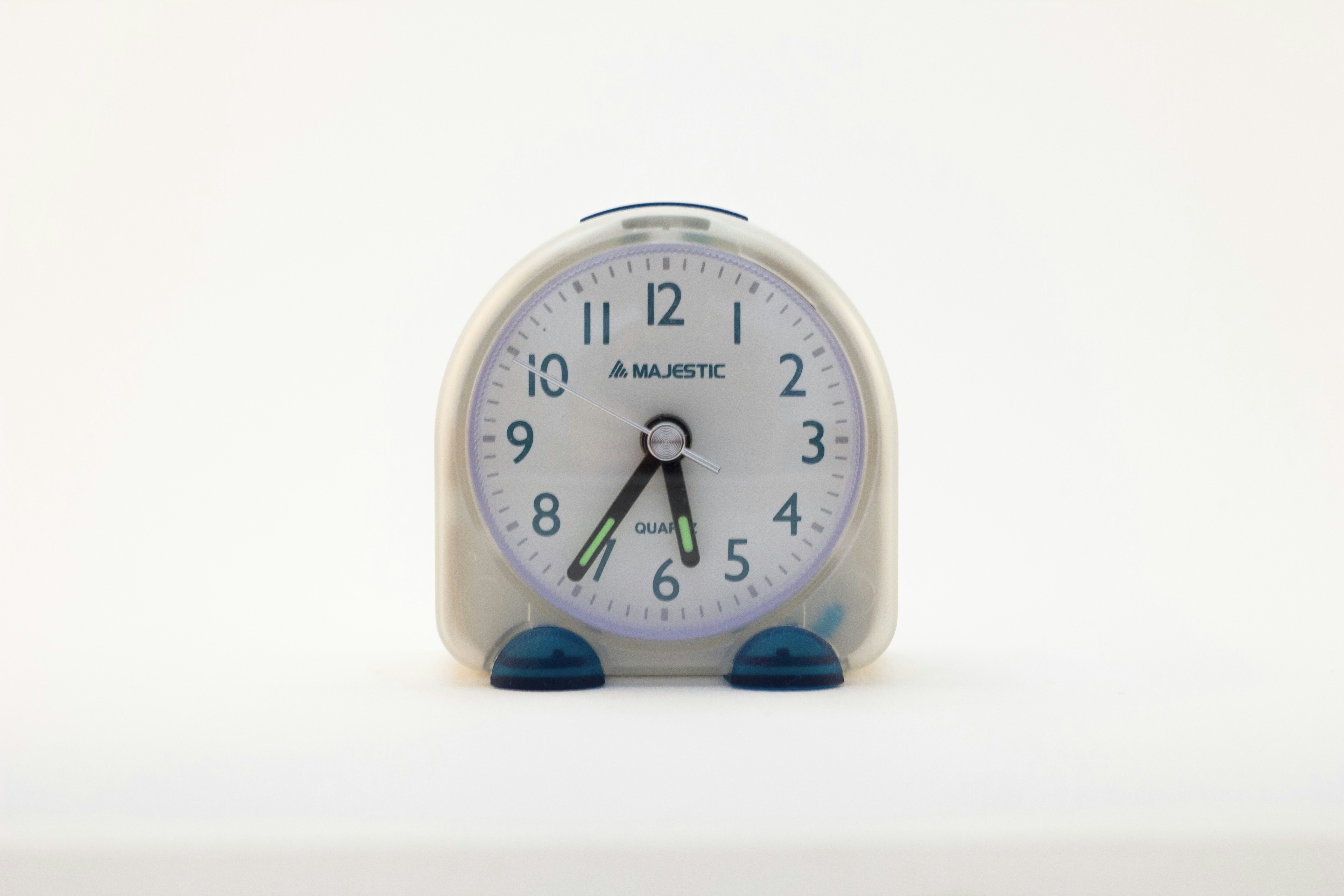 Tiny Clock, Big Presence: A Petite Quartz Alarm Clock on a Pure White Studio