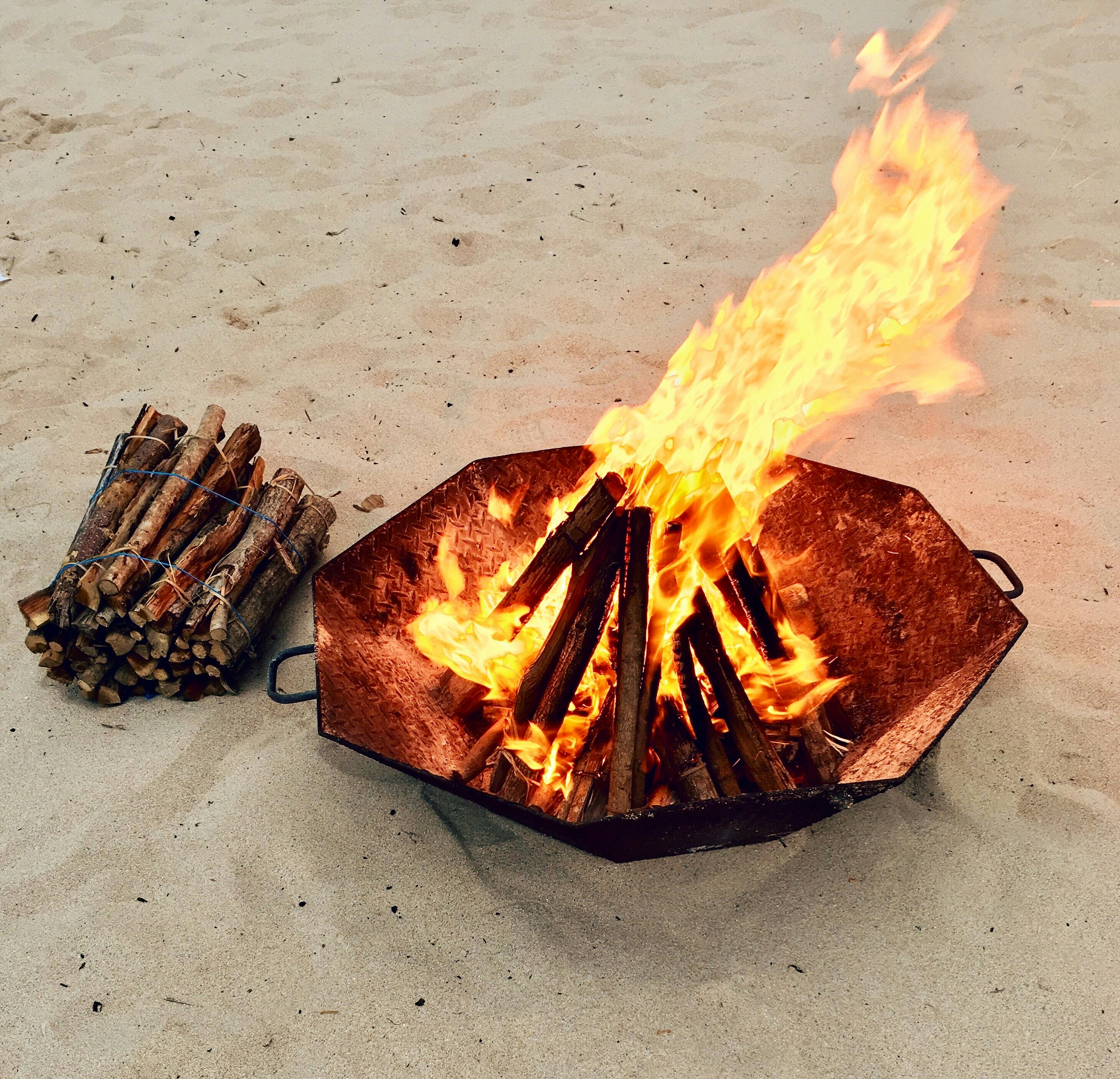 Sparks in the Sand: A Compact Fire Pit and Stacked Kindling