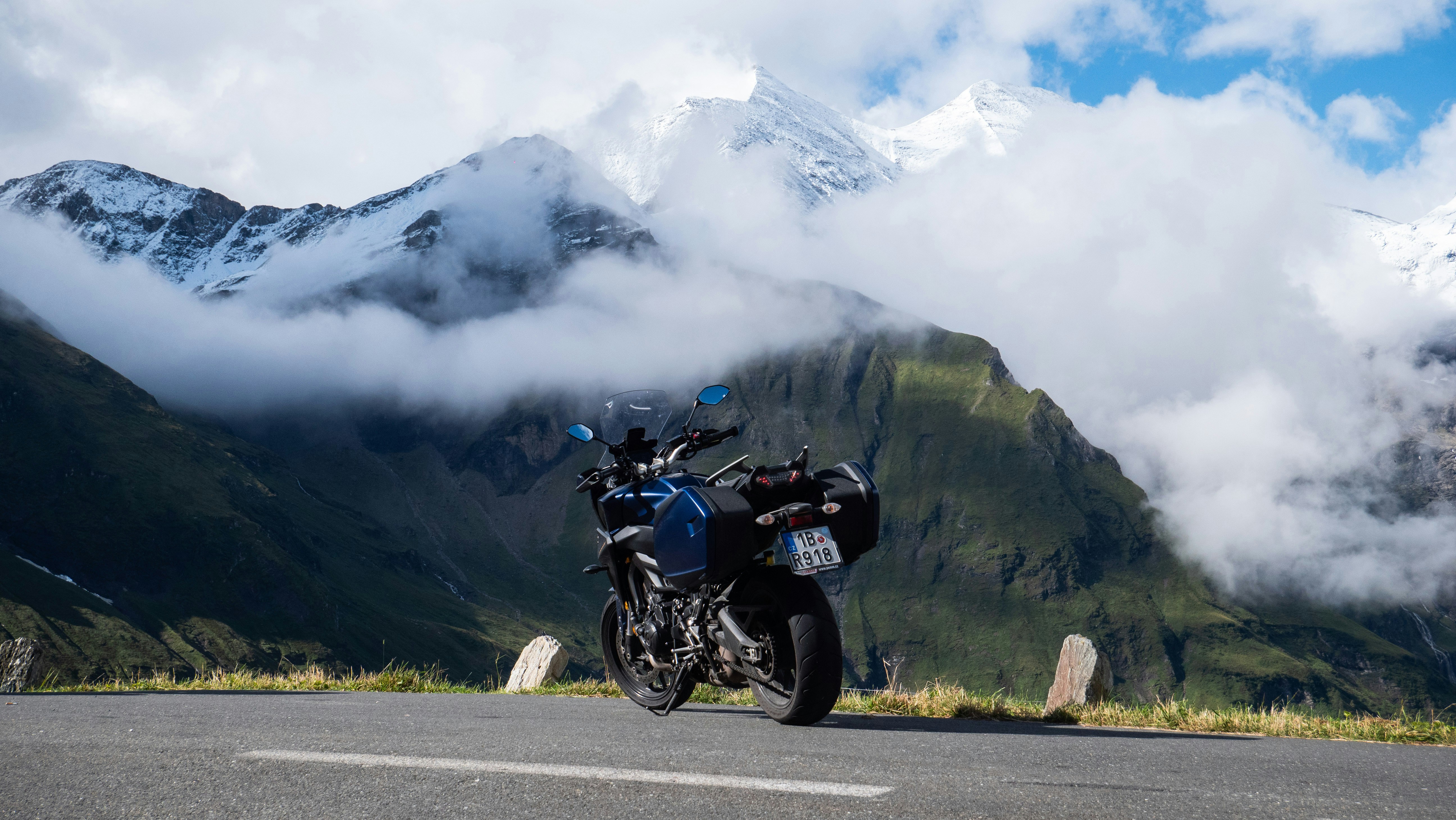 Black and blue sports bike on road near mountain during daytime photo ...